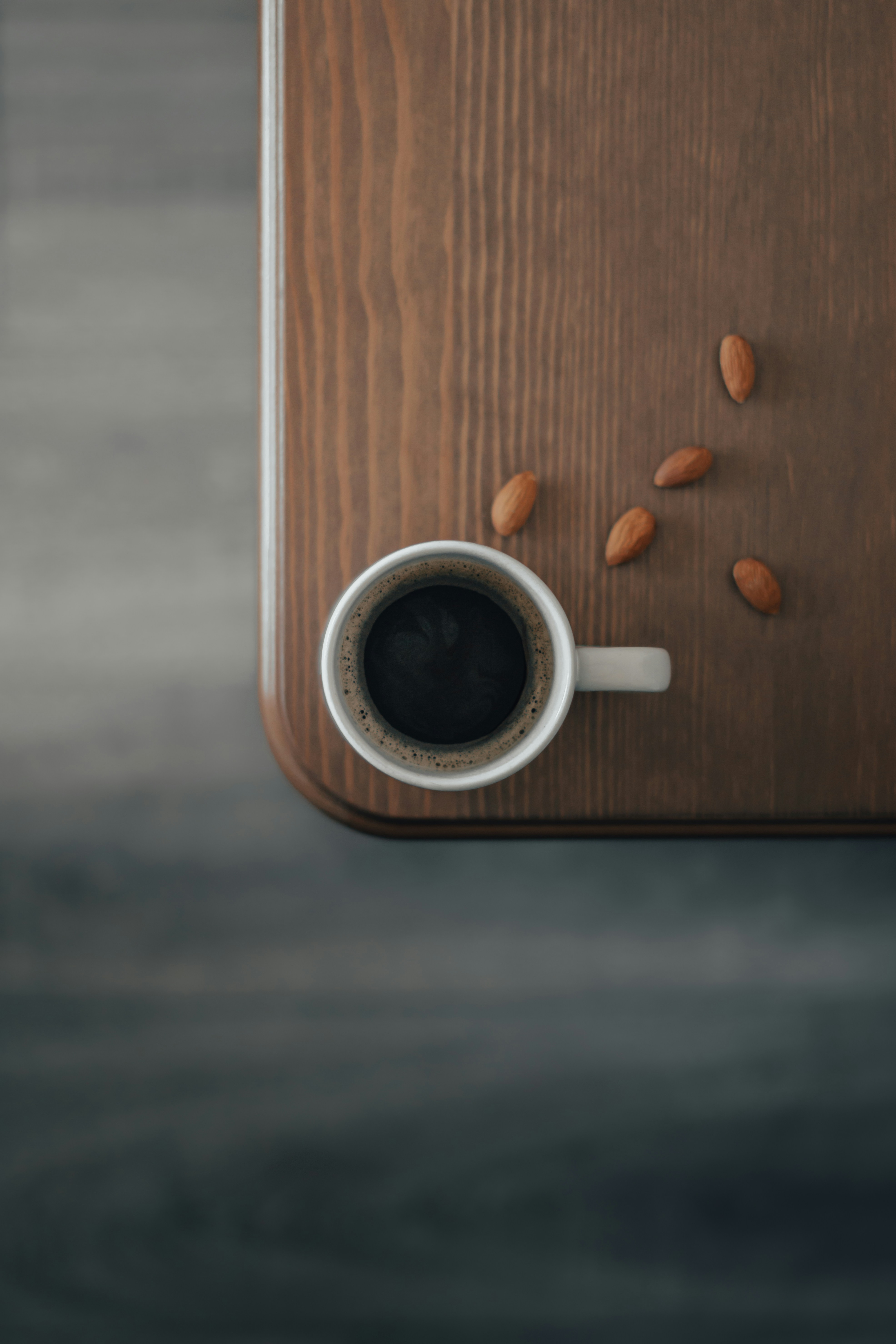 white ceramic mug on brown wooden table