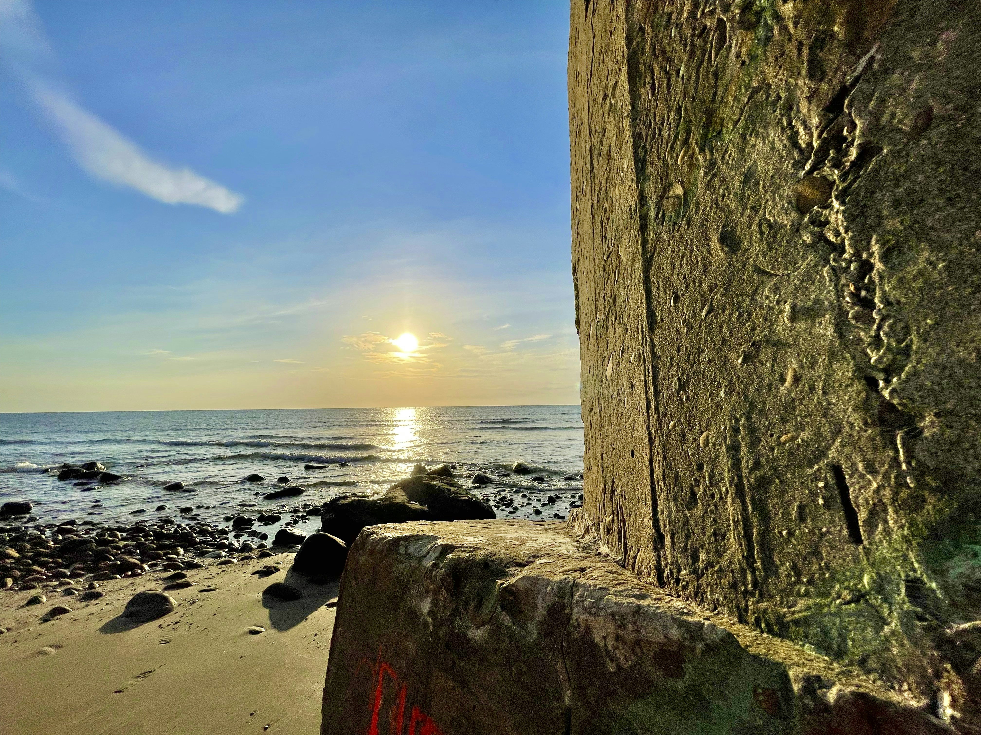 Sunlit Shoreline Framed by Weathered Concrete