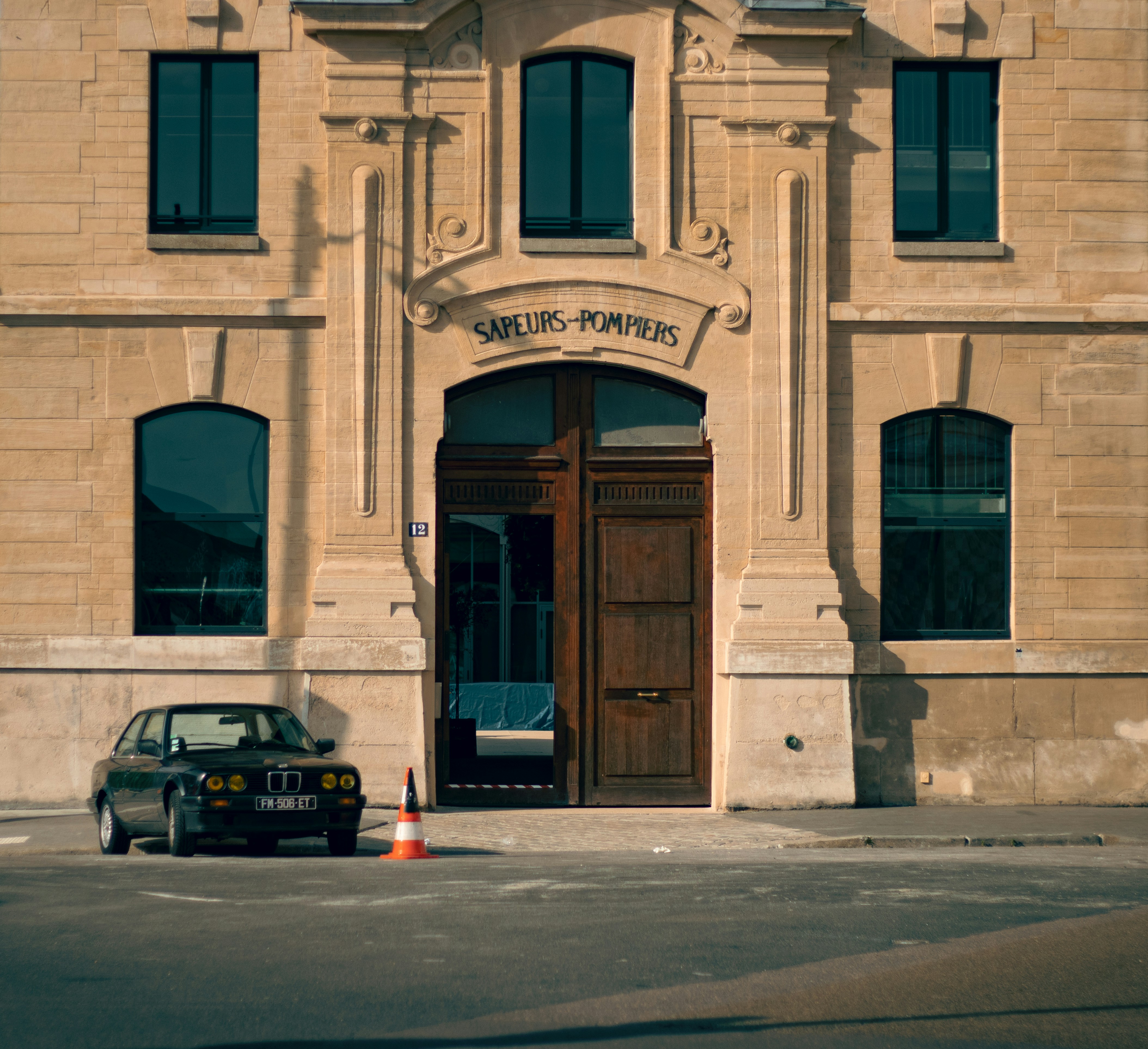 Ornate Firehouse Doorway on a Sunlit French Facade