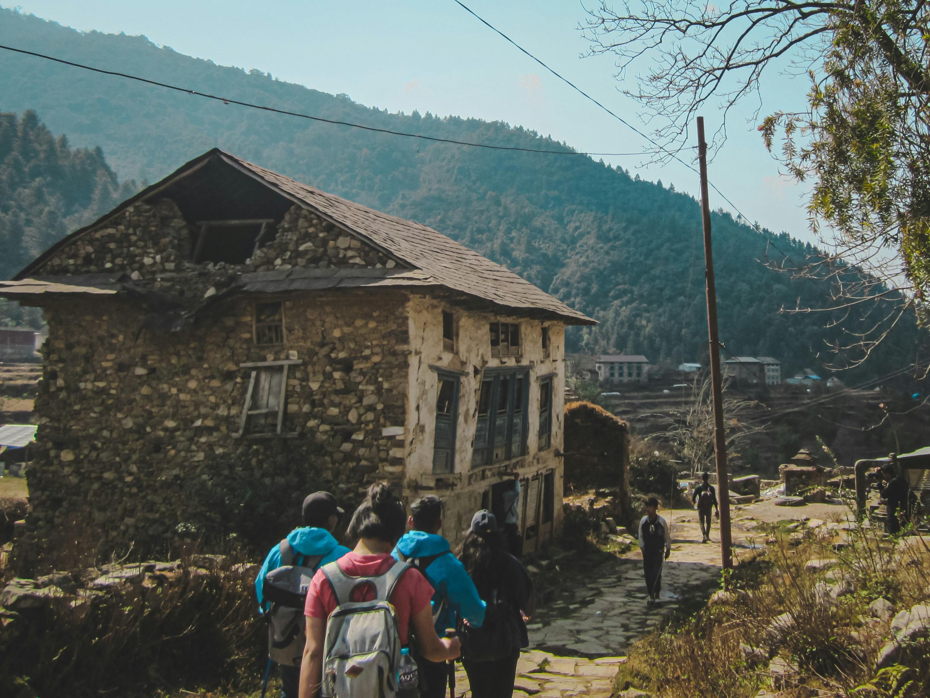 Hikers Enter the Mountain Village