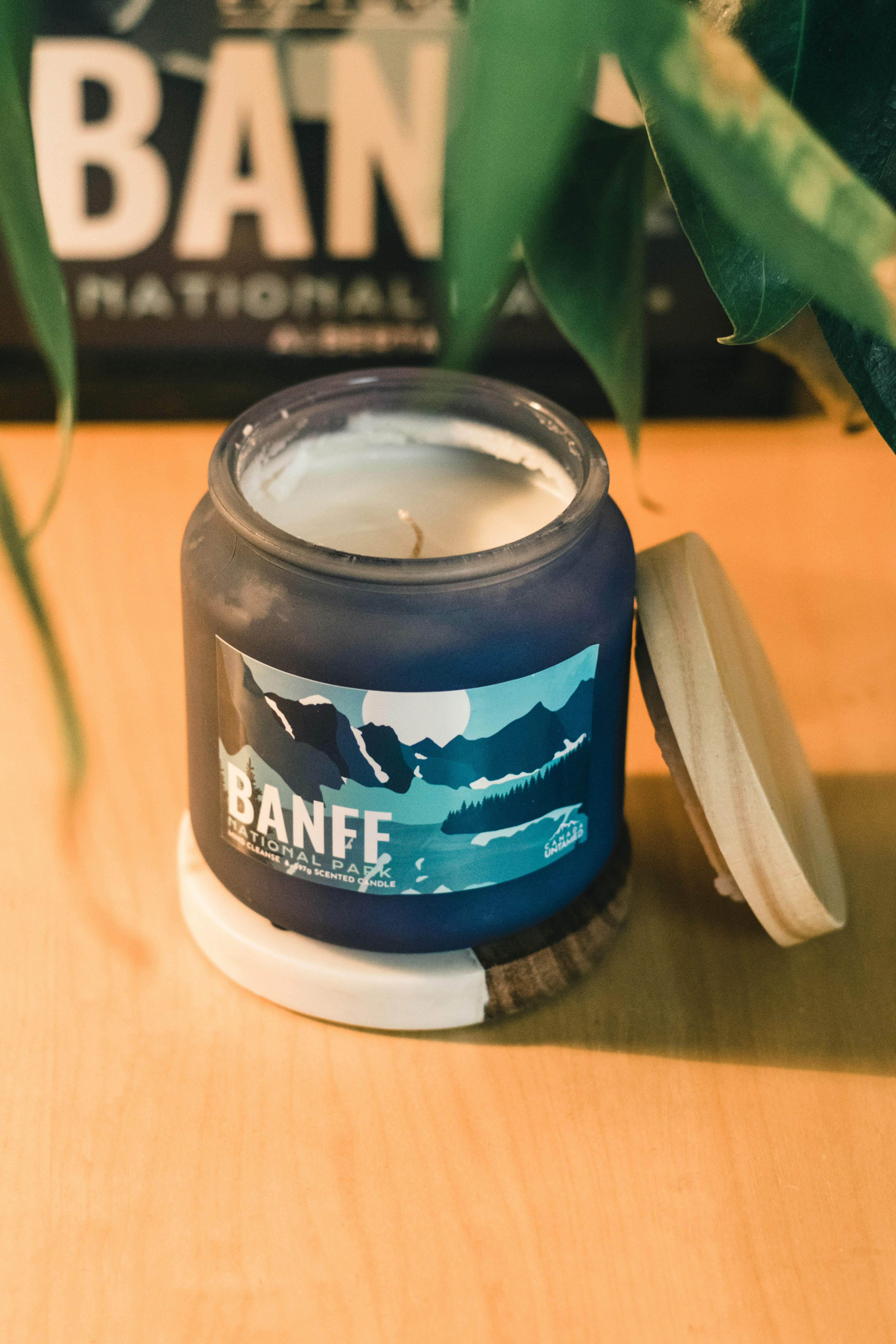 Candle Jar on a Wooden Surface with Banff Label — Cozy Desk Scene