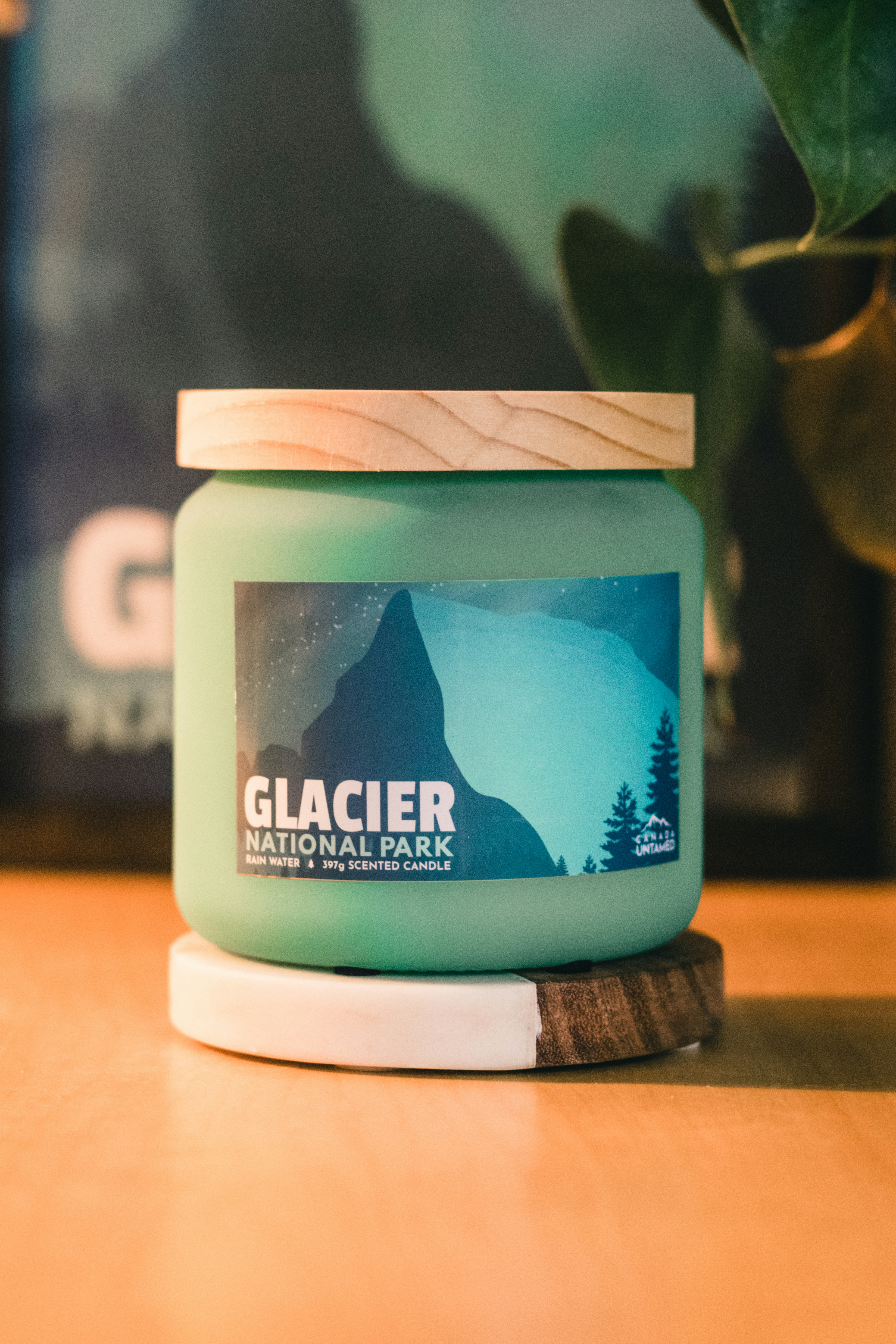 Glacial Glow: Mint Candle with Mountain Label on a Two-Tone Wooden Stand