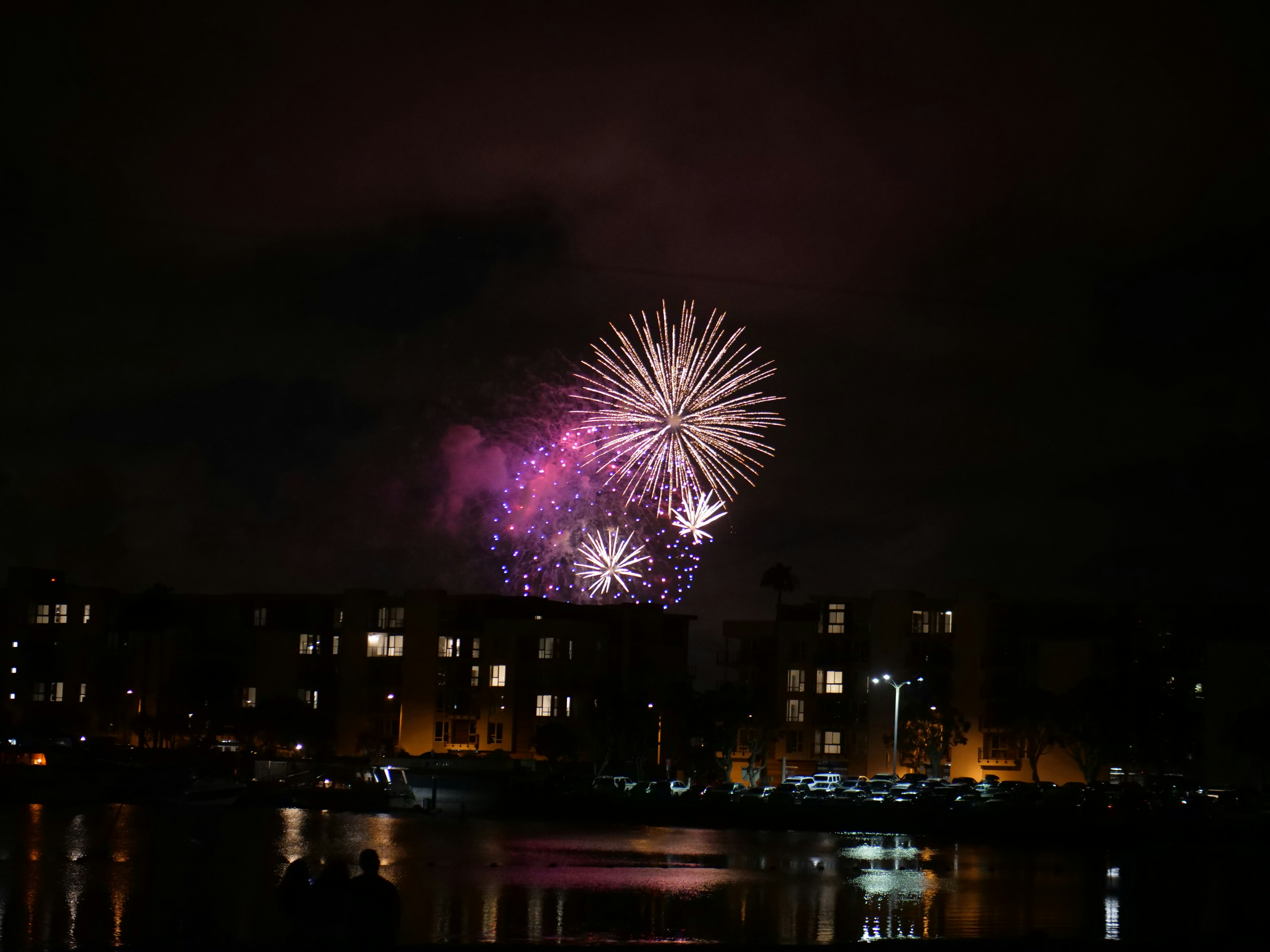 Fireworks display over city buildings during night time photo – Free ...