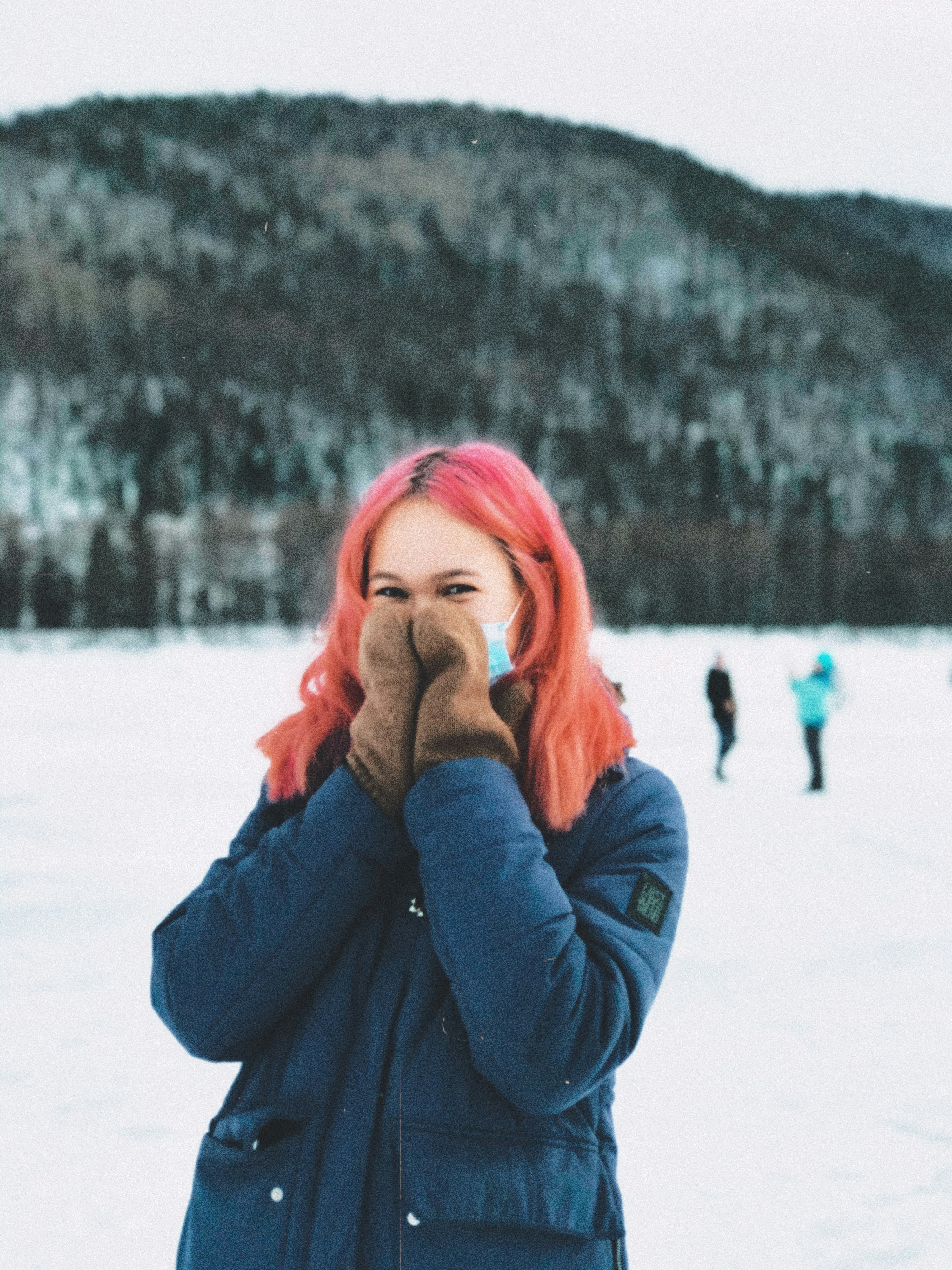 Pink-haired warmth in a snowy field