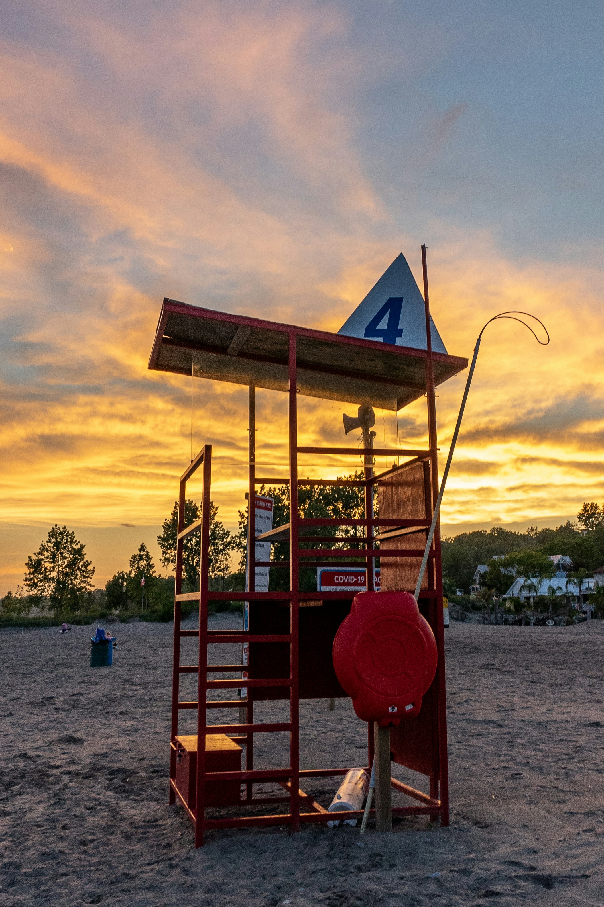 Red Watchtower at Dusk: A Lifeguard's Quiet Vigil on the Beach