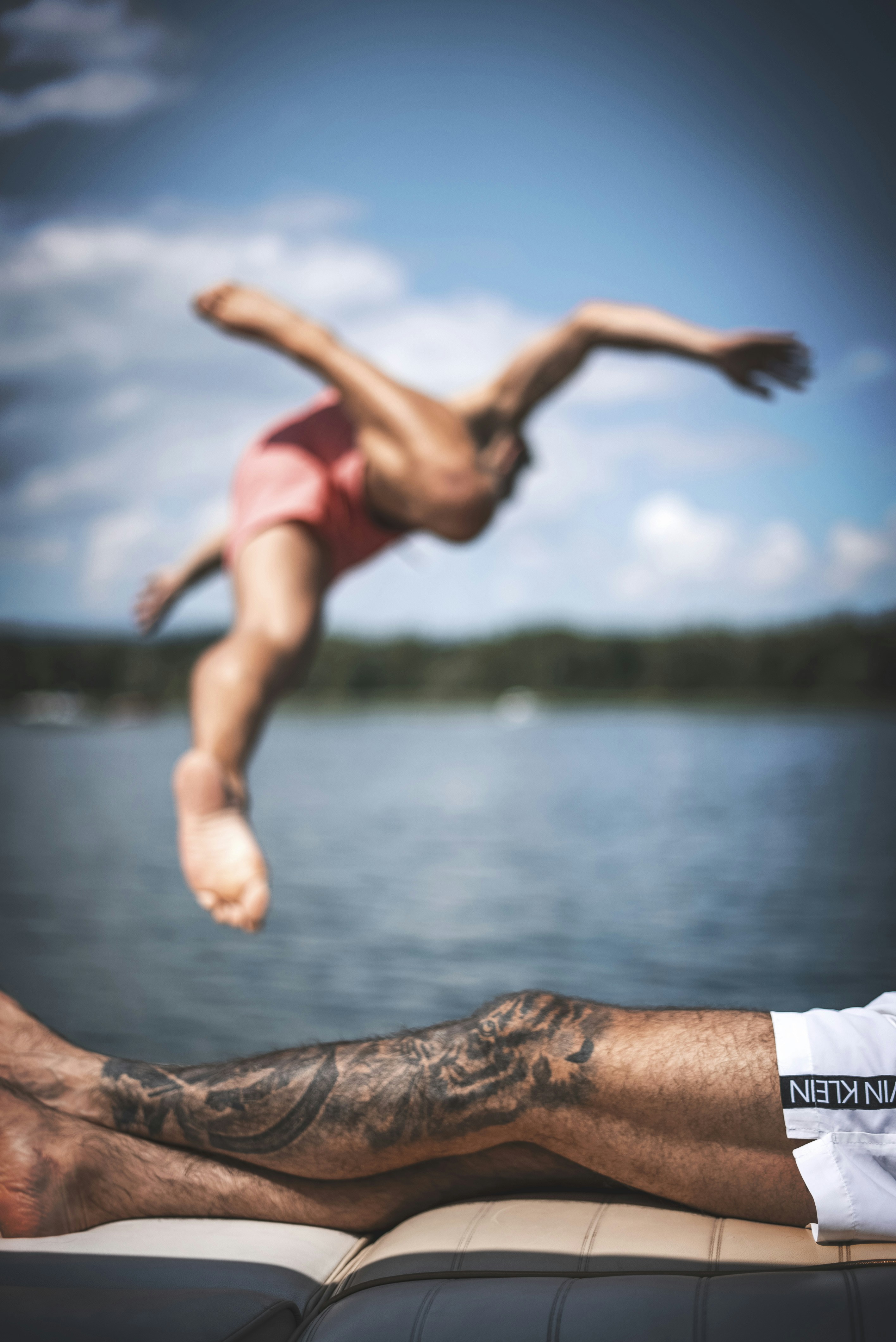 Airborne in Pink: A Lakeside Leap Caught in Soft Focus