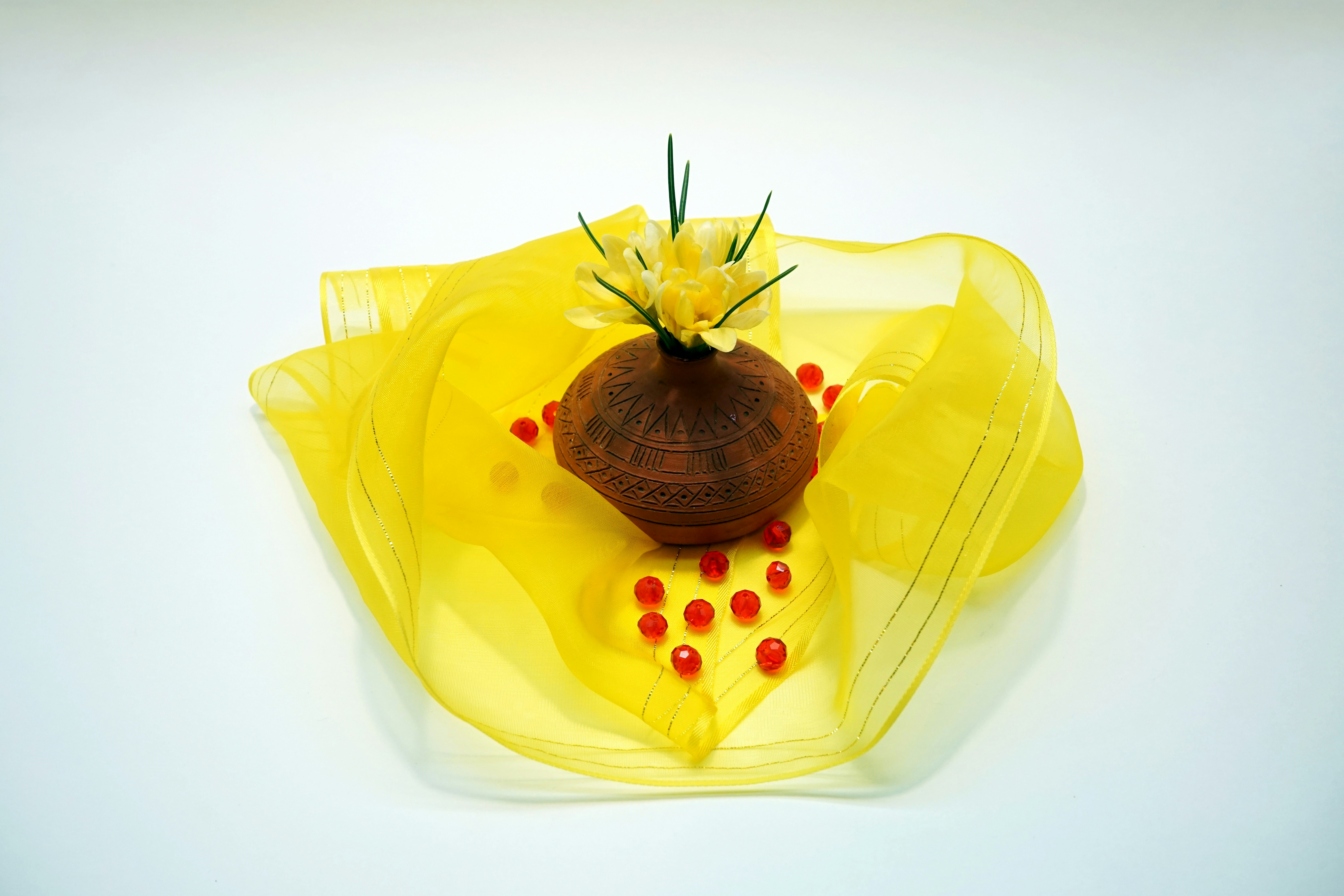 Sunlit Yellow Veil Embraces a Central Ceramic Vase