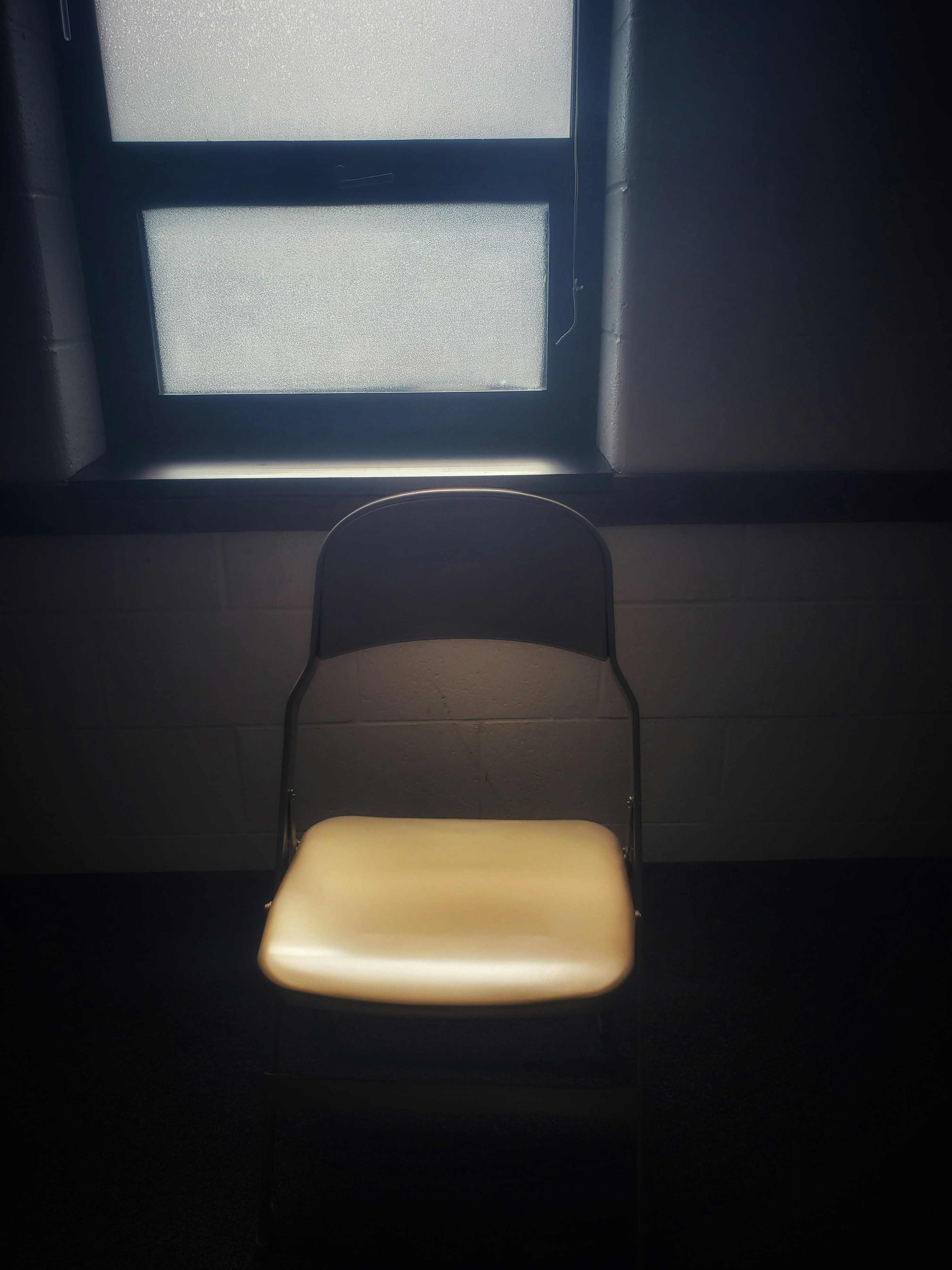 white and black chair beside window