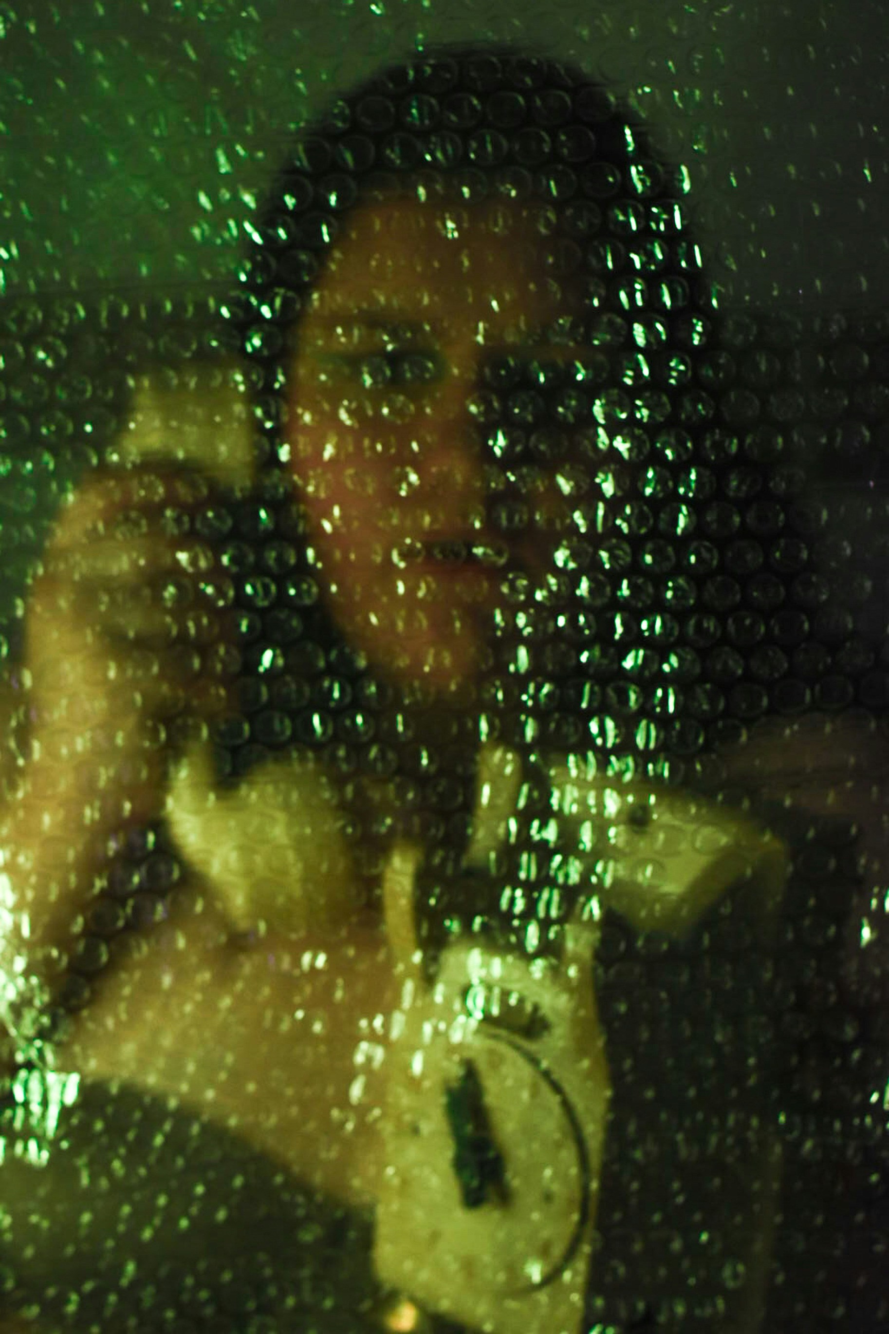 Face in a Green Nightglass: Portrait Through a Dim Bubbley Refraction