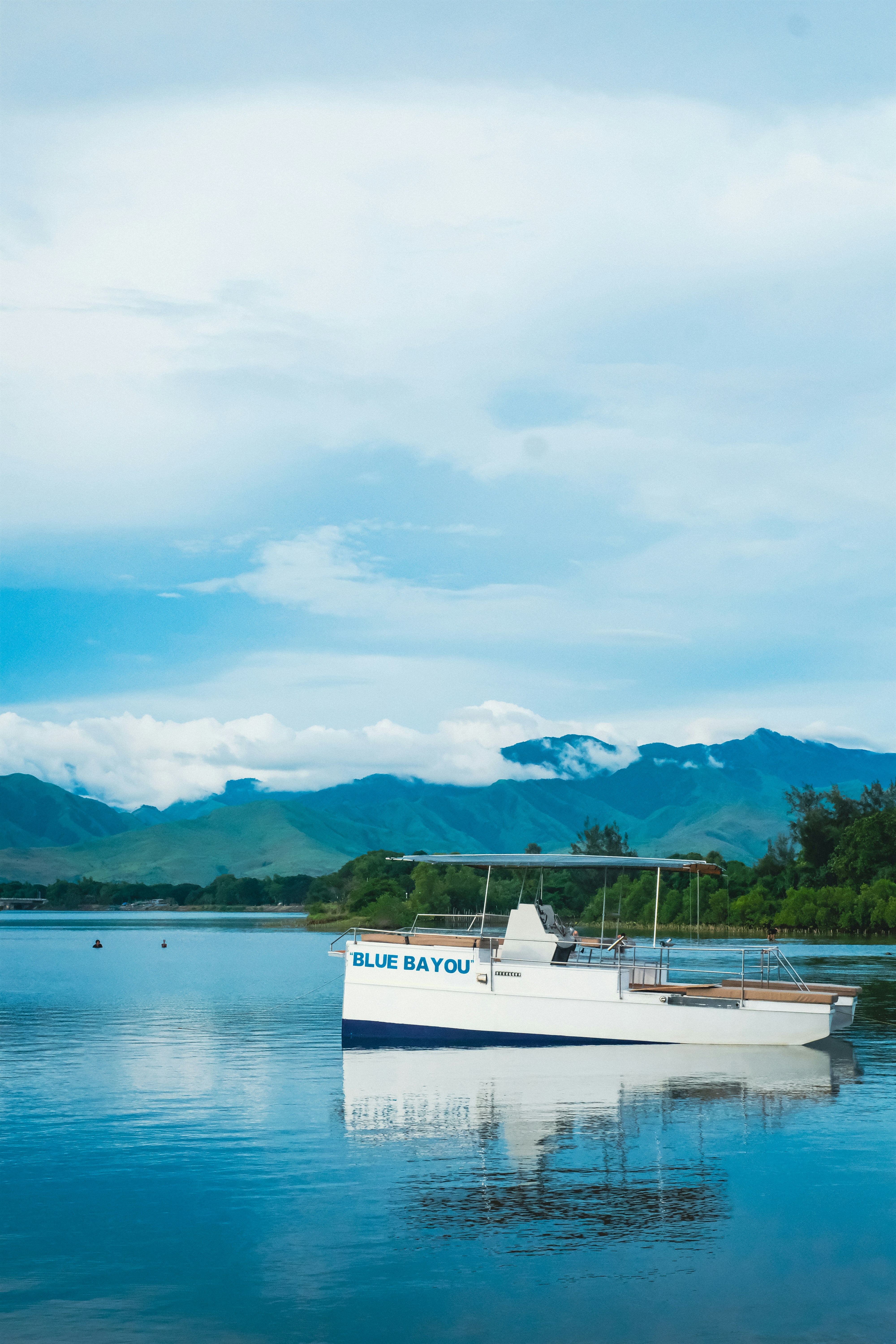 Blue Bayou Afloat: A Lone Boat on Tranquil Waters
