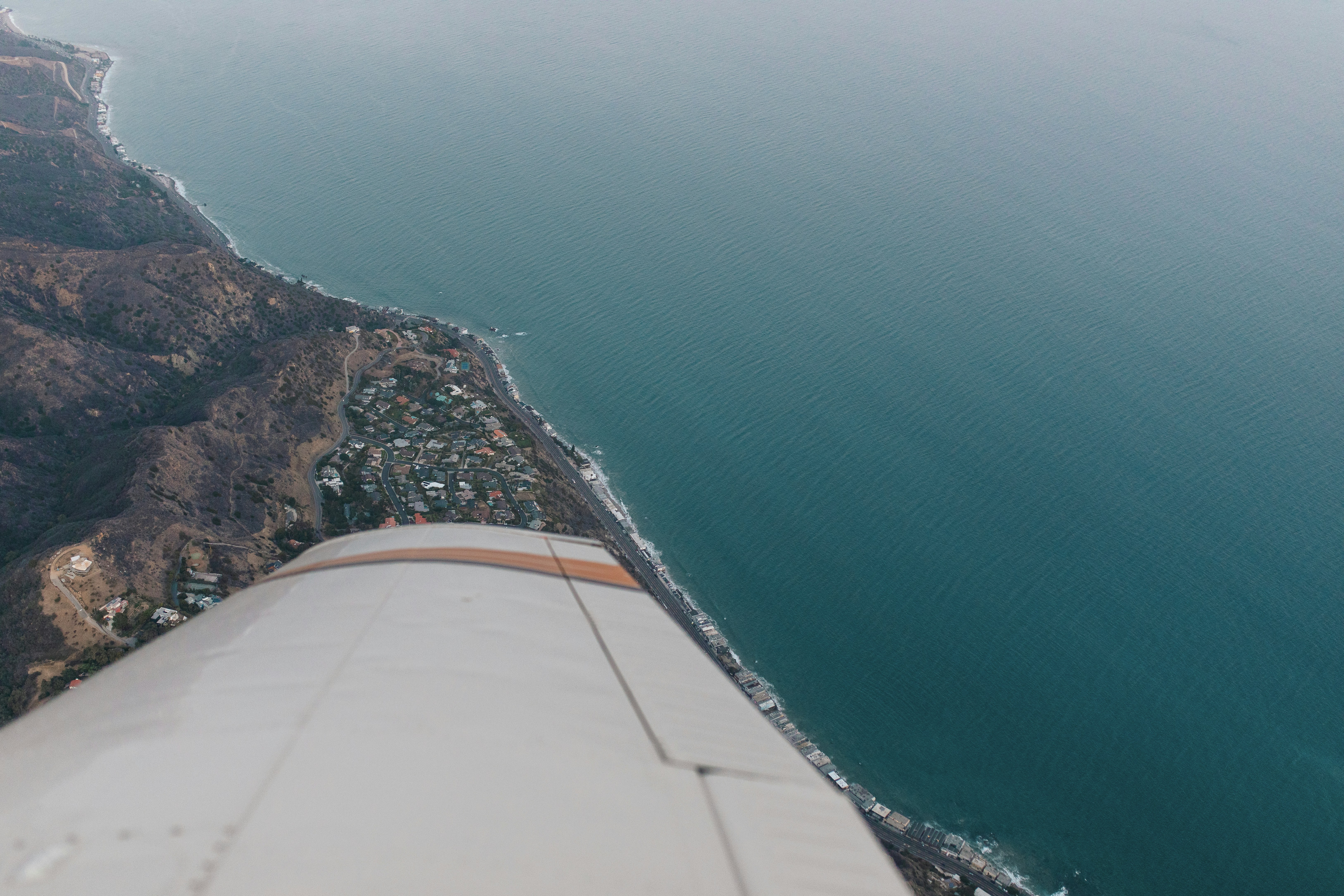 Wingtip Vista: Where rugged coastline meets the endless sea