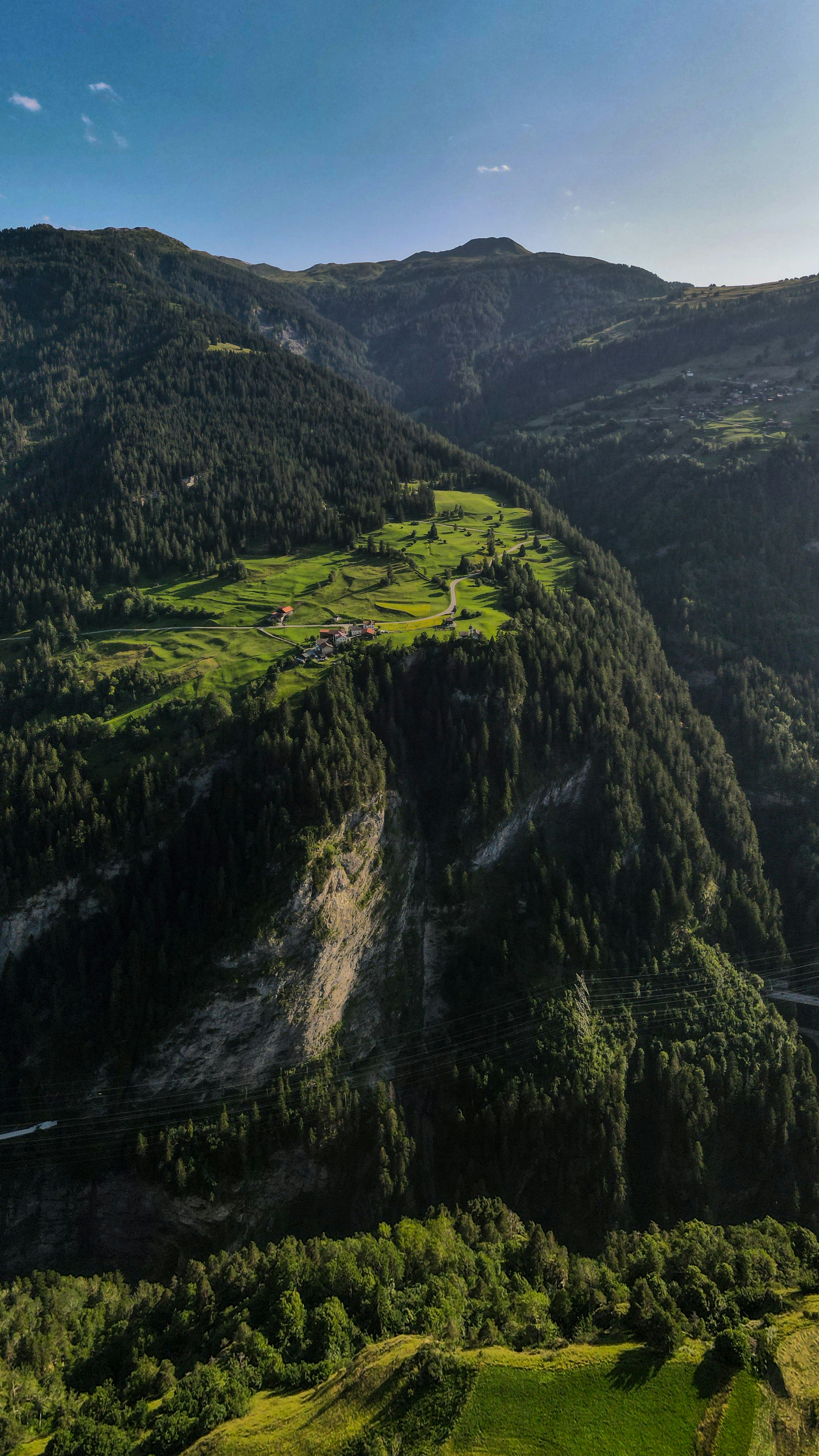 Patchwork Plateau: Alpine Green Oasis on a Cliffside