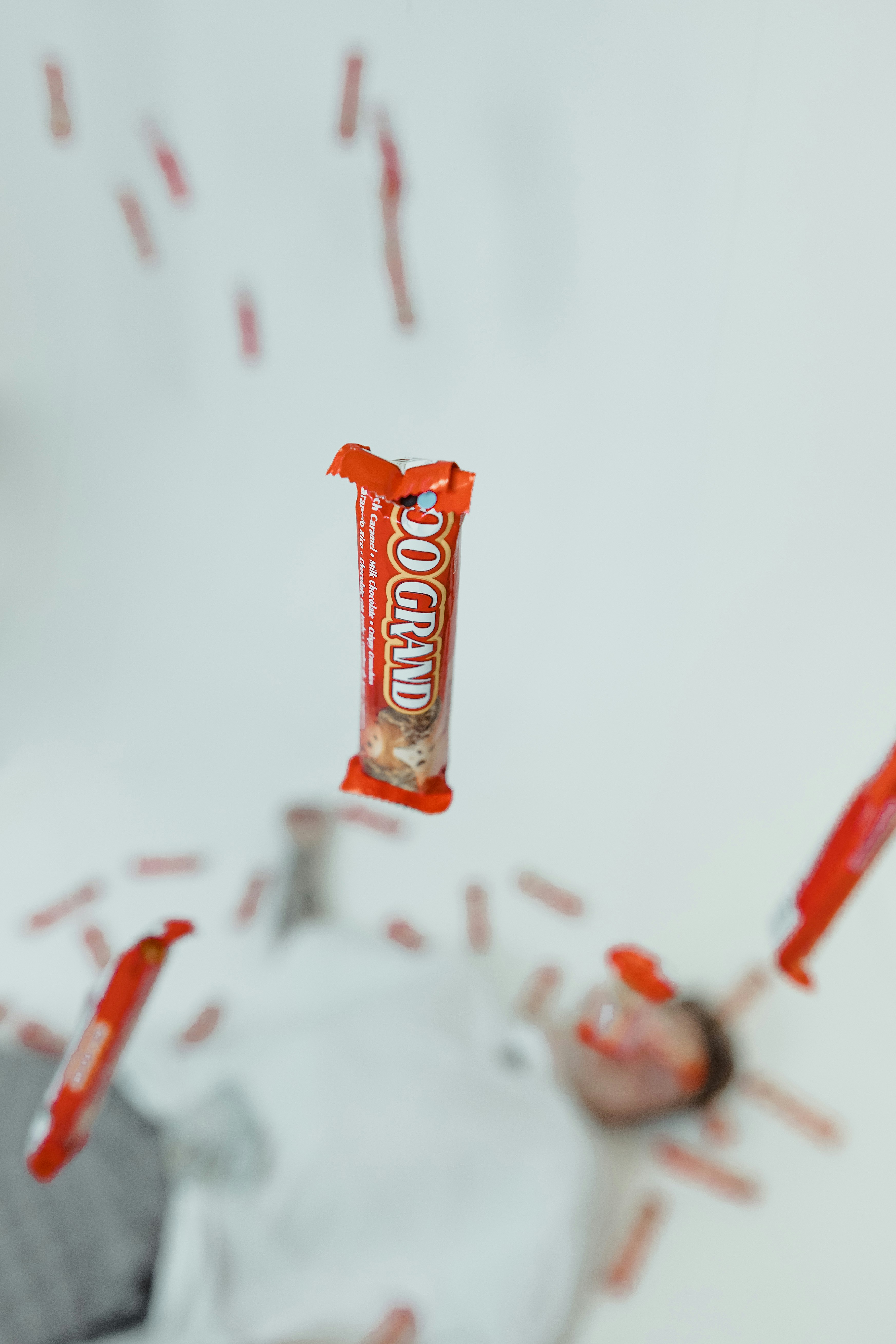 Suspended Candy: A Burst of Red Against a Dreamy White Void