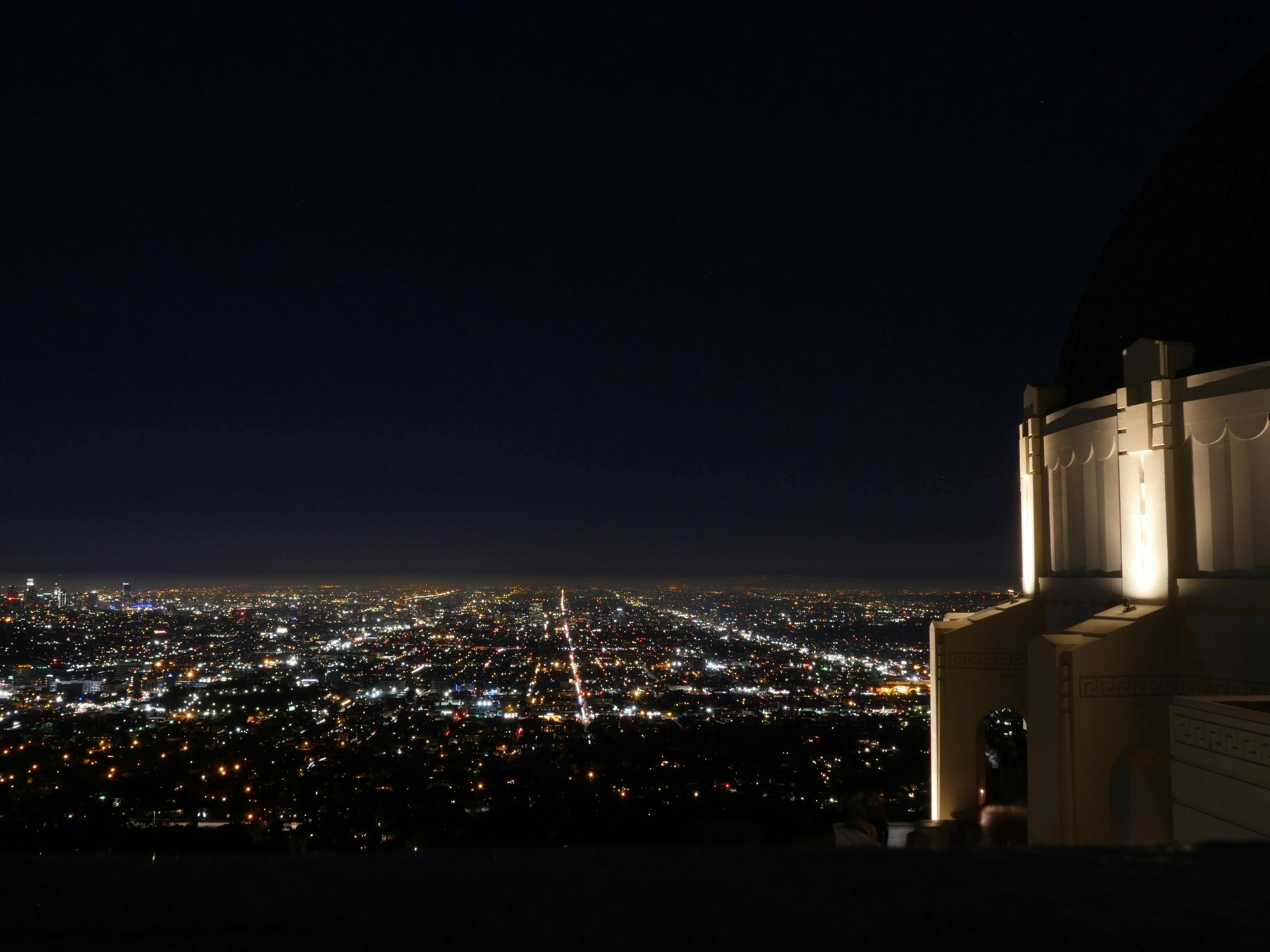 Nightbound Terrace: City Lights from a Moonlit Balcony