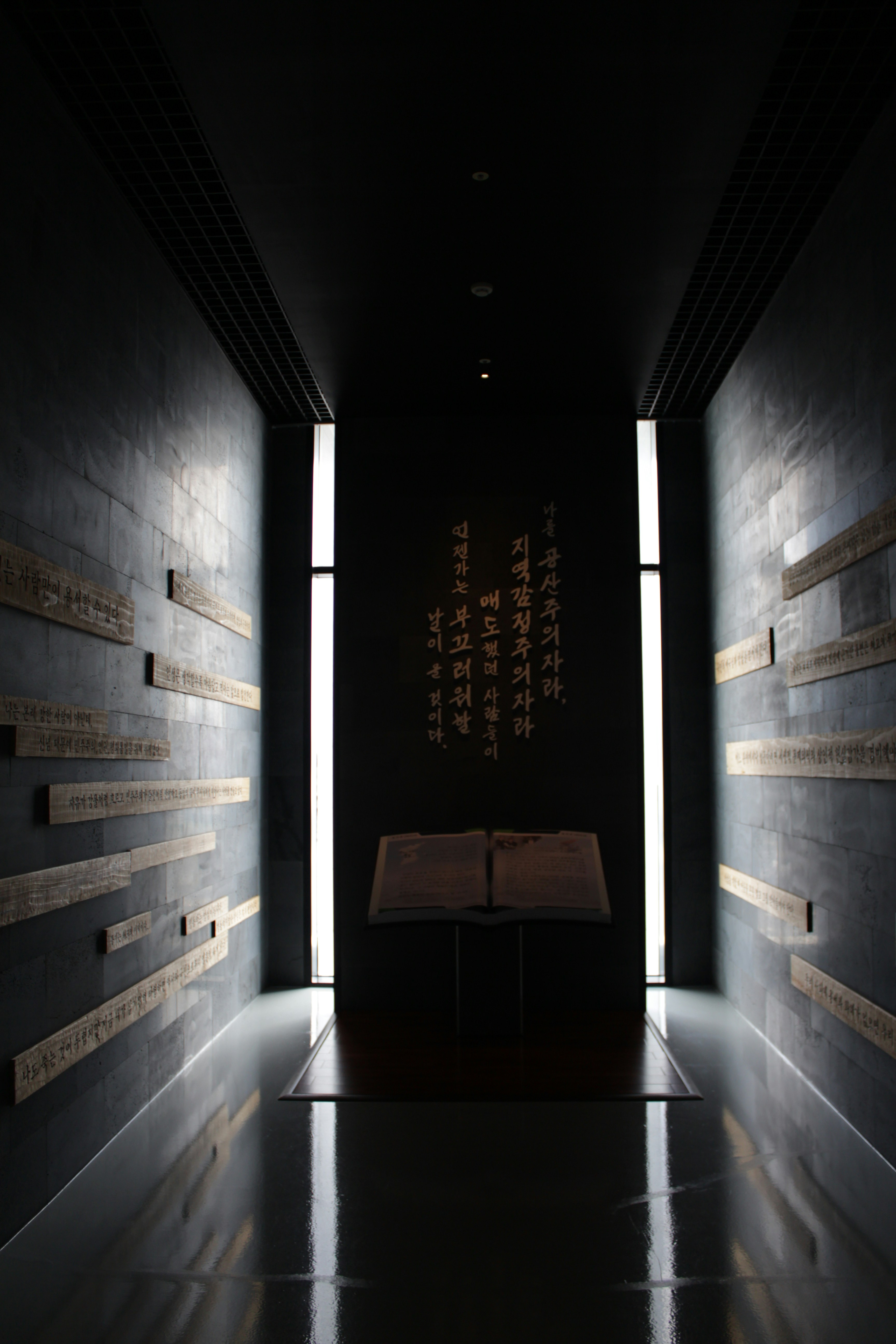 Silent Hall of Letters: A Dim Corridor Framing an Open Scripture