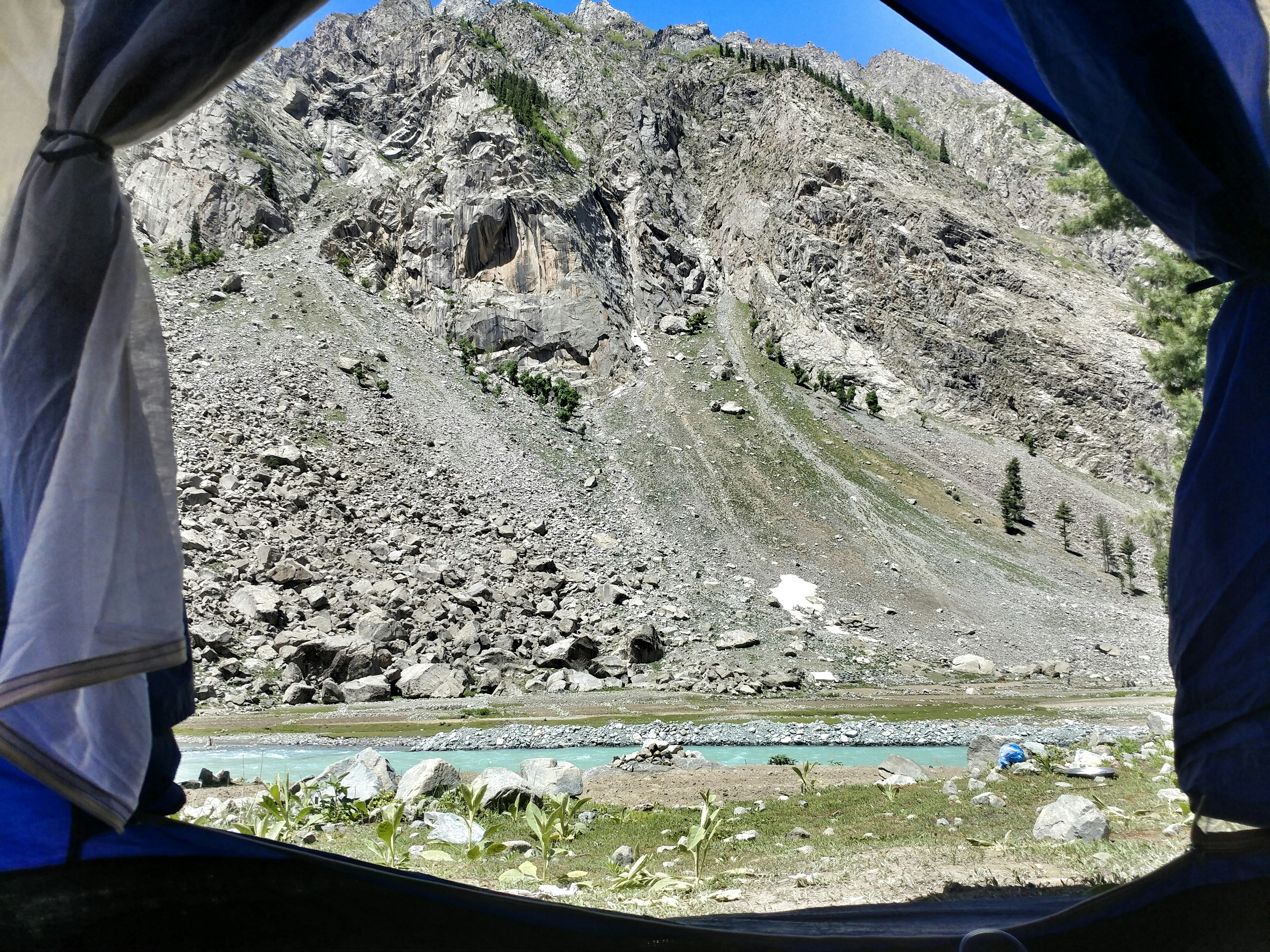 Framed Summit Vista: Alpine Ridge Beyond a Tent Opening