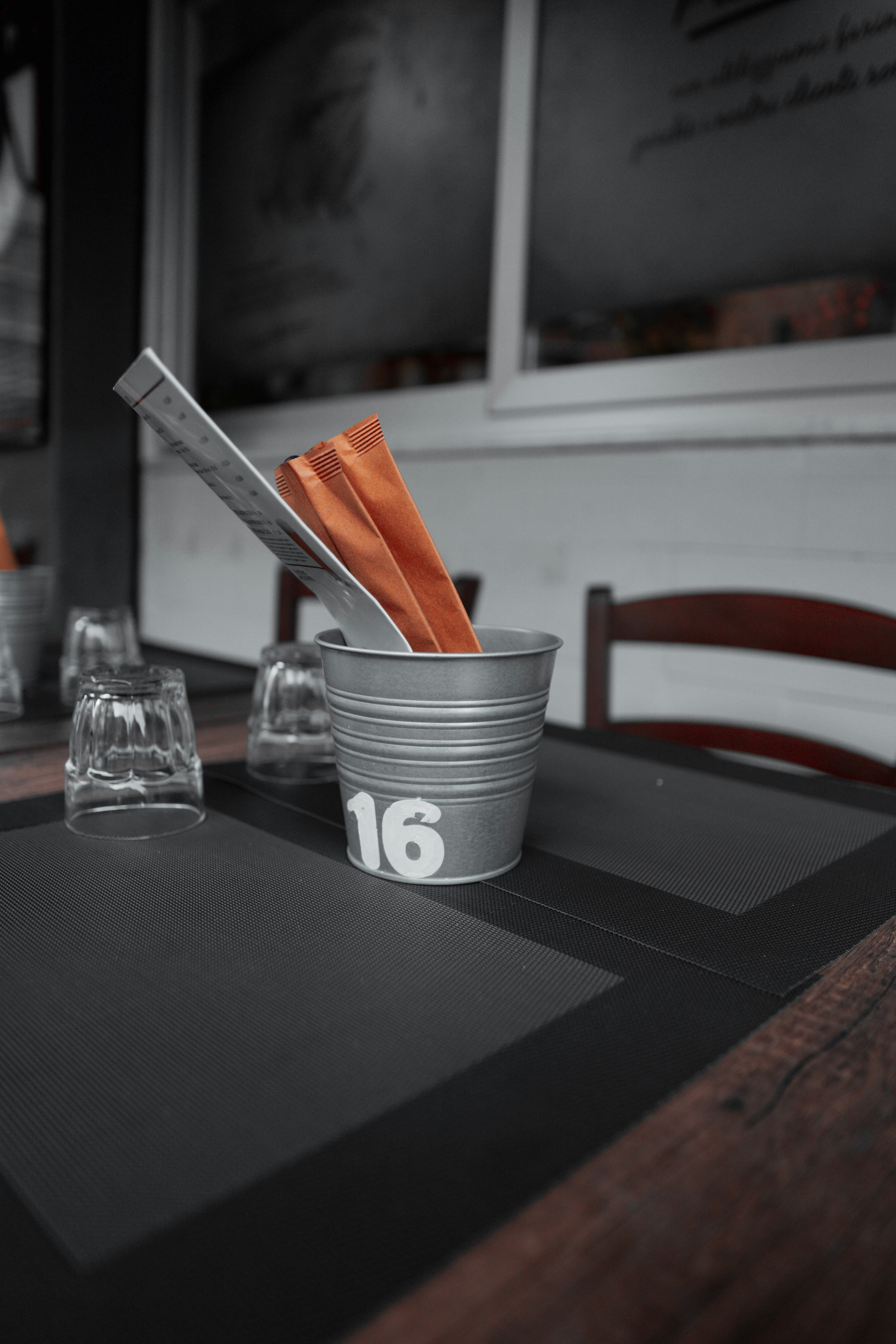 Metallic Bucket with Napkins on a Table