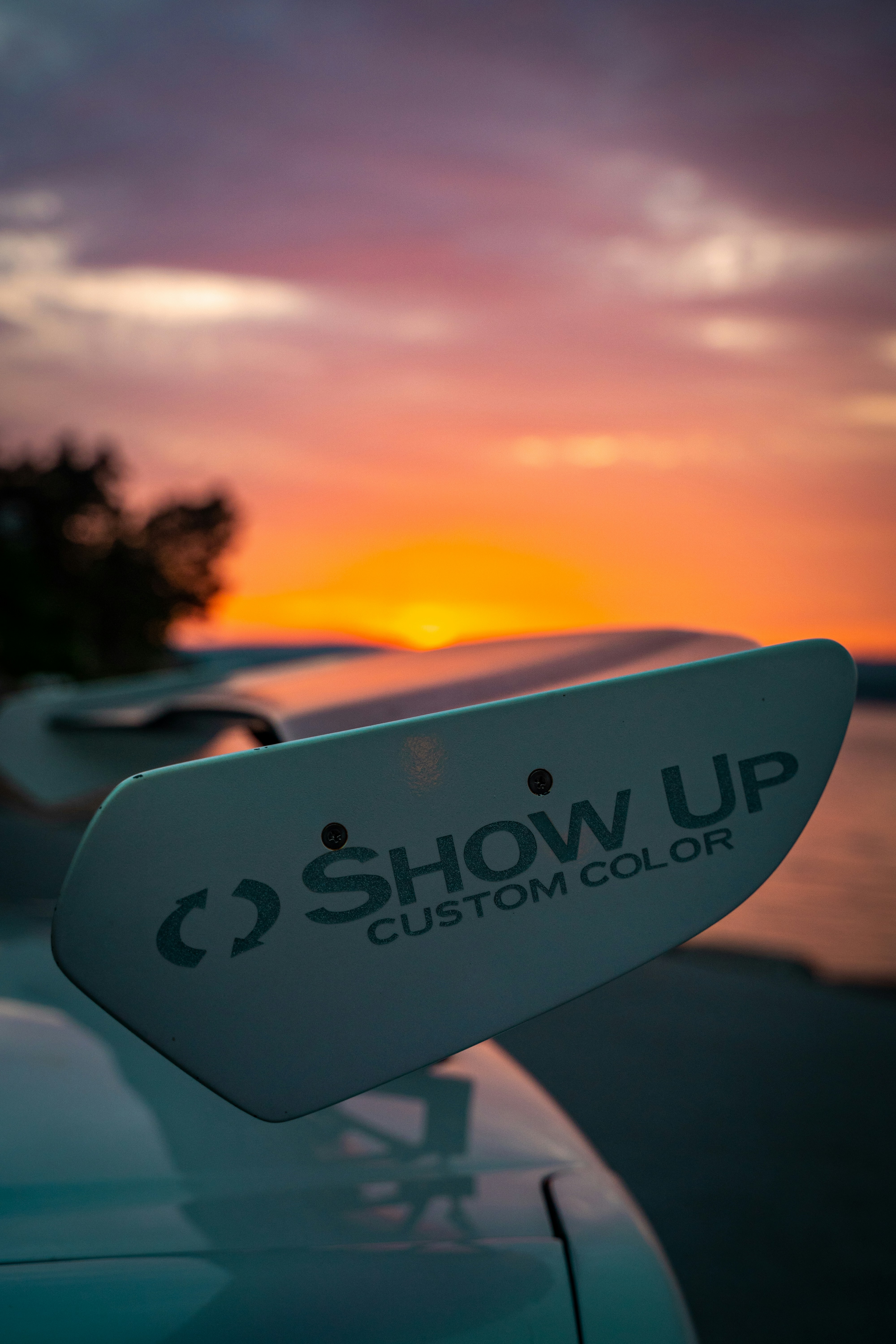 Sunset Lift: The Show Up Wing against a Glowing Sea