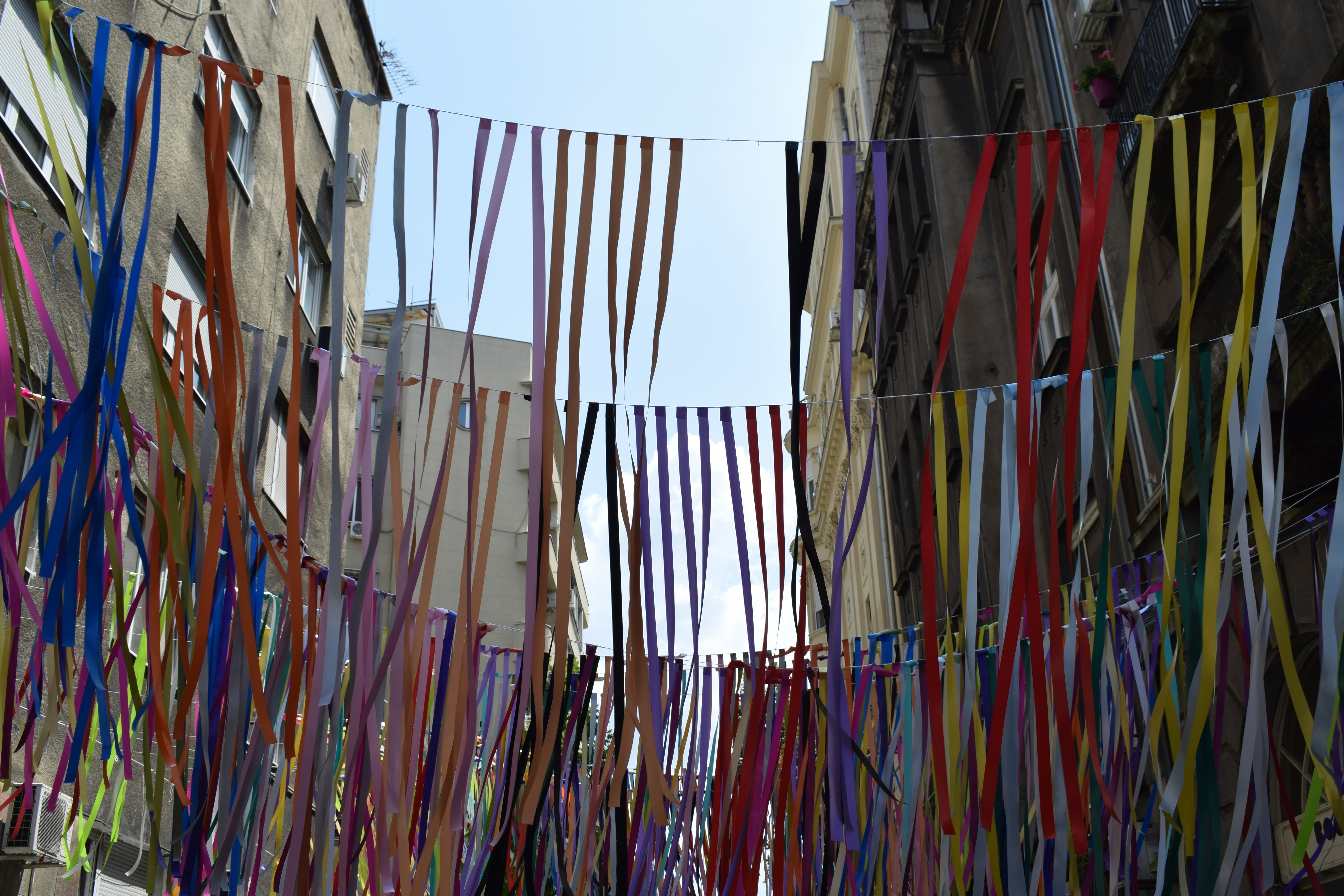 Festive Strands Over a Narrow Open Street