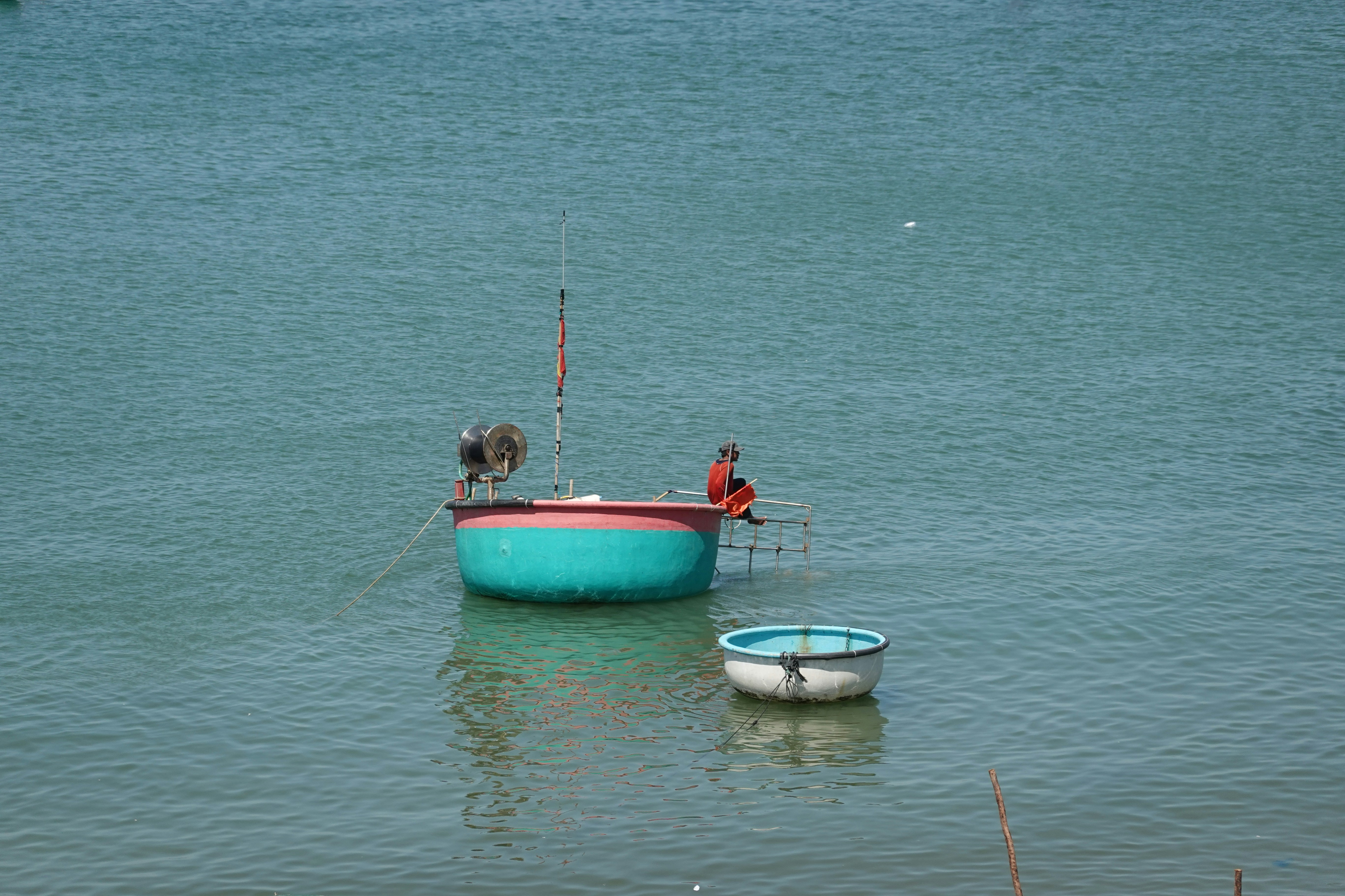 Teal Hull, White Dinghy: A Quiet Maritime Portrait