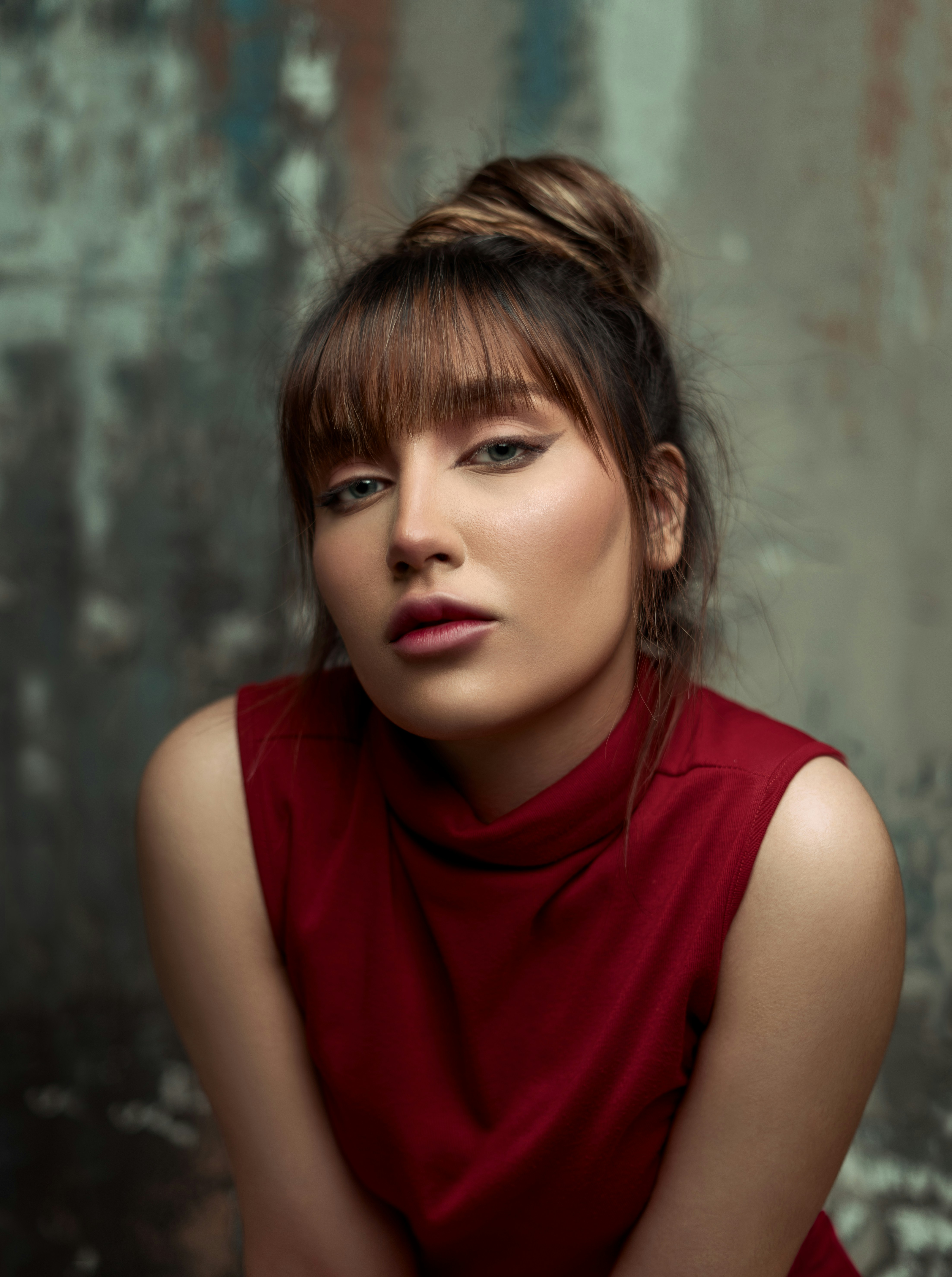 Crimson Quiet: A Portrait Against a Weathered Concrete Backdrop