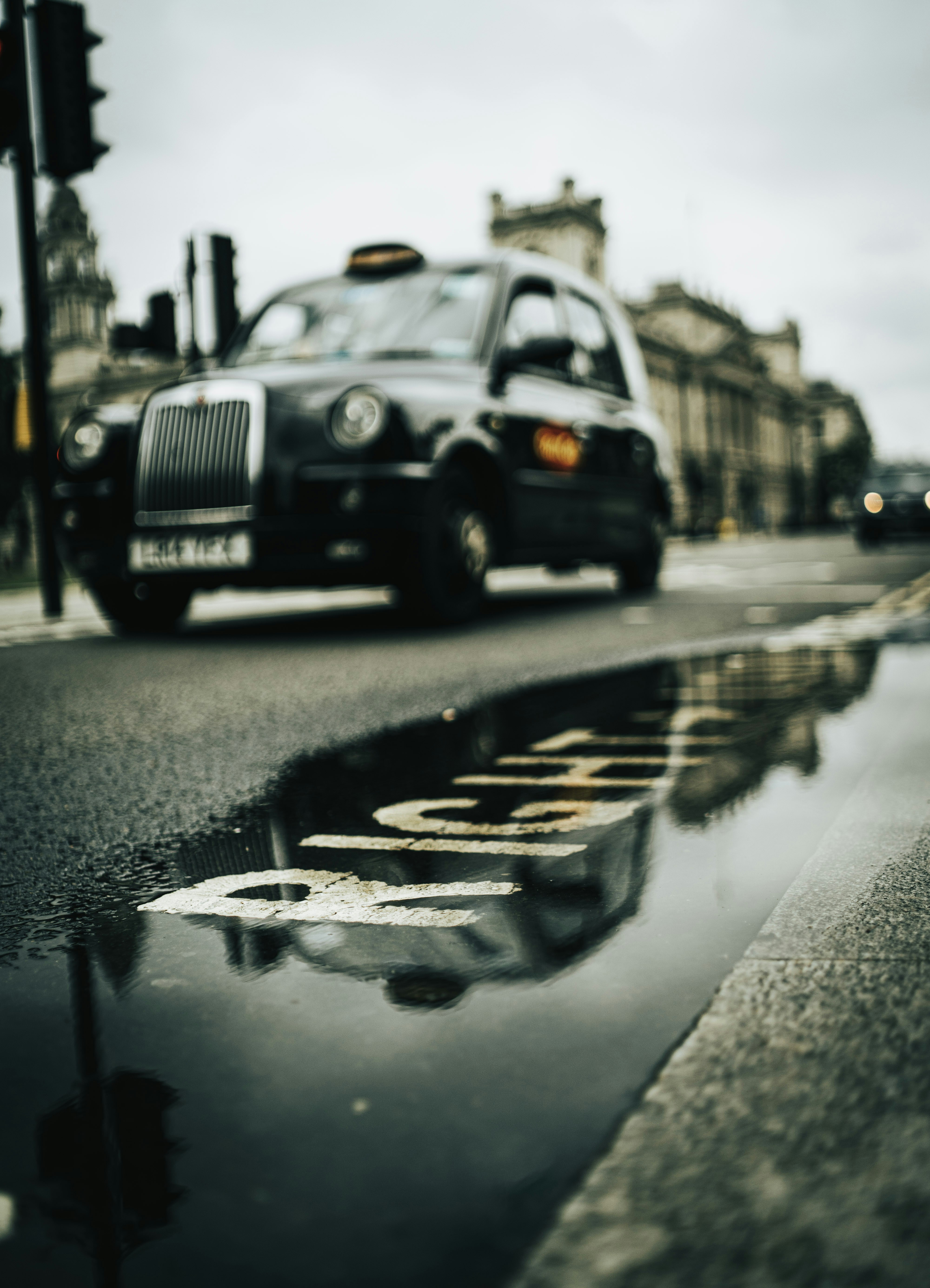 London Taxi at the Edge of a Puddle: A Tilt-Shift Street Moment