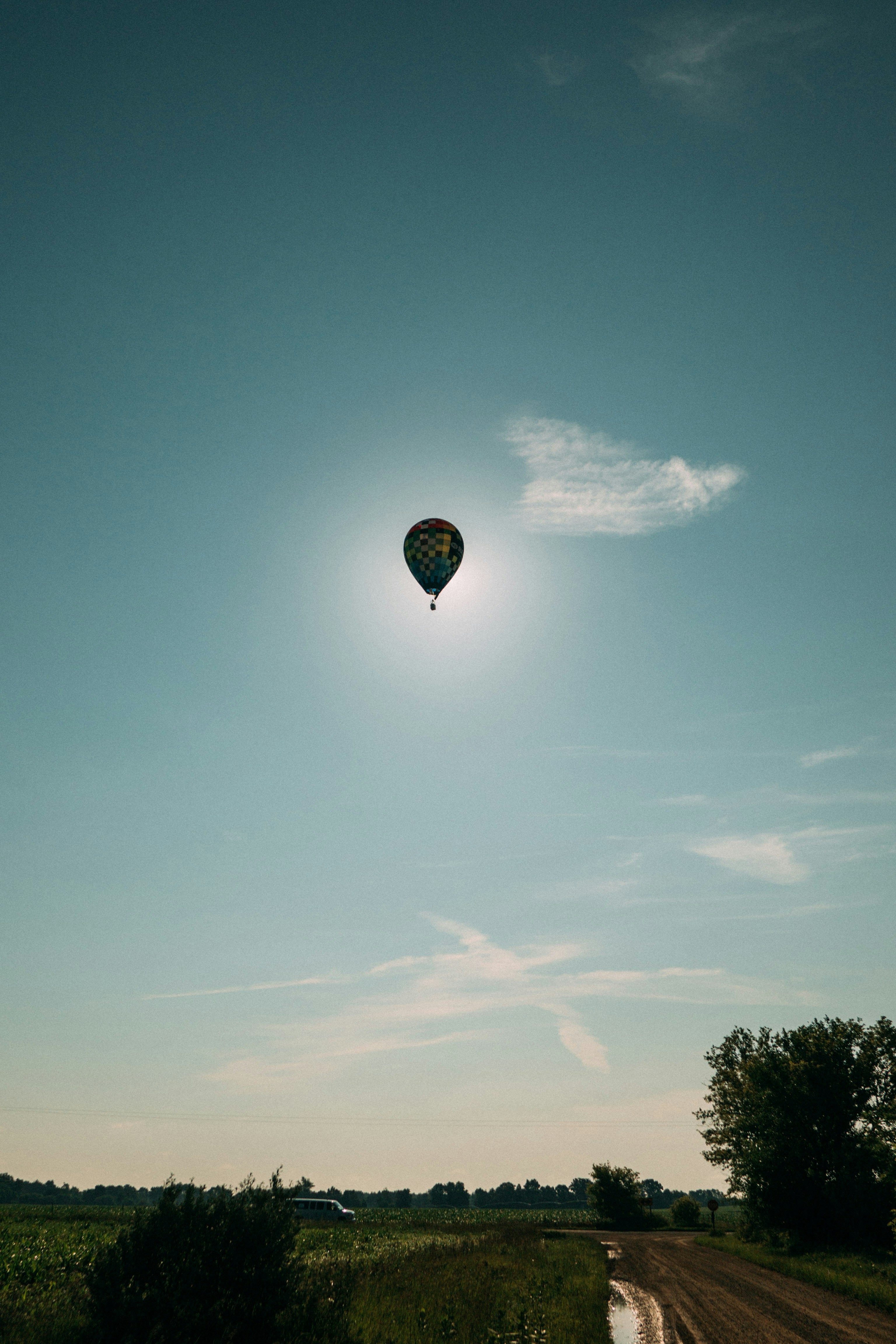 Haloed Balloon Drifting Over a Quiet Prairie Road