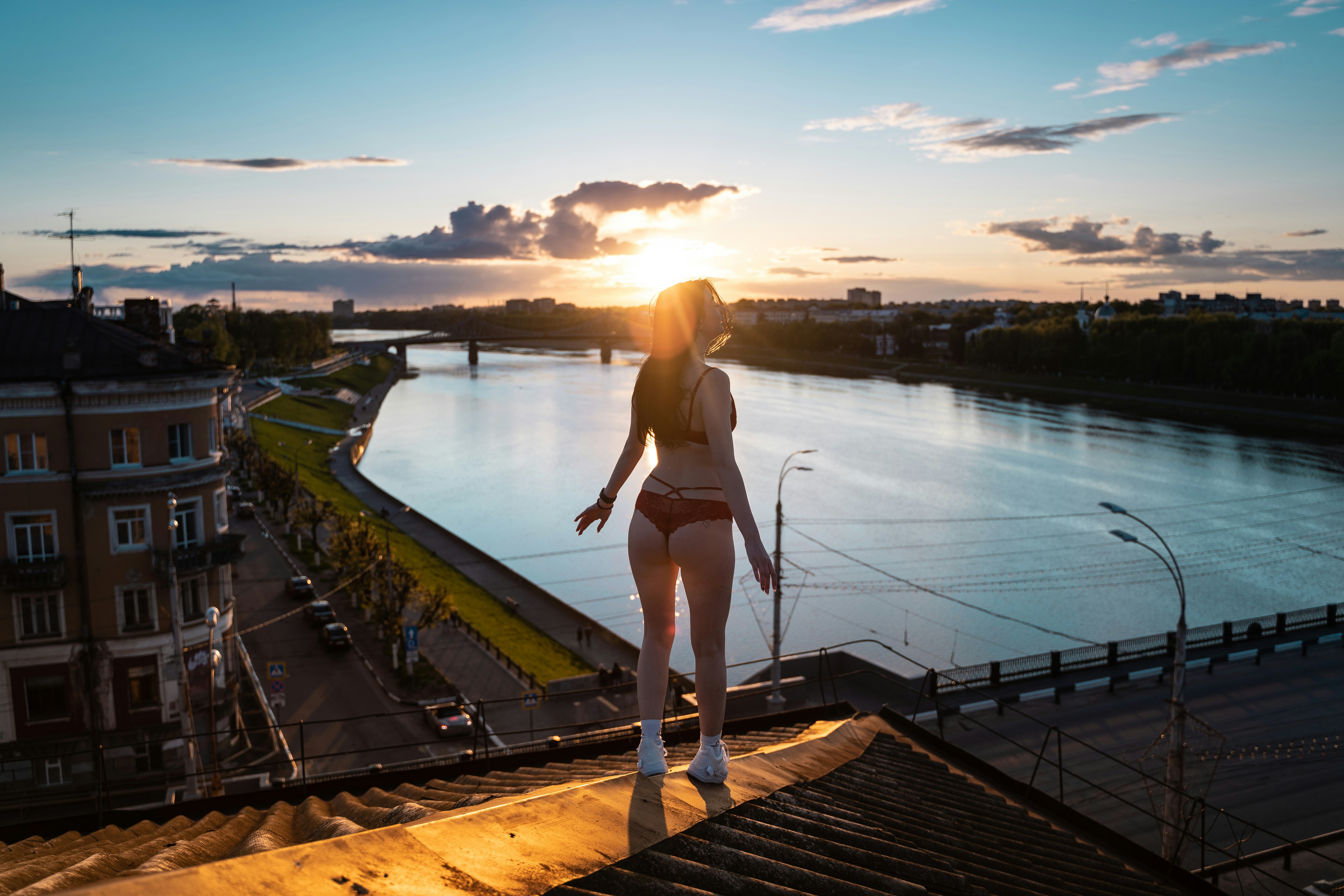 woman in pink bikini standing on dock during daytime