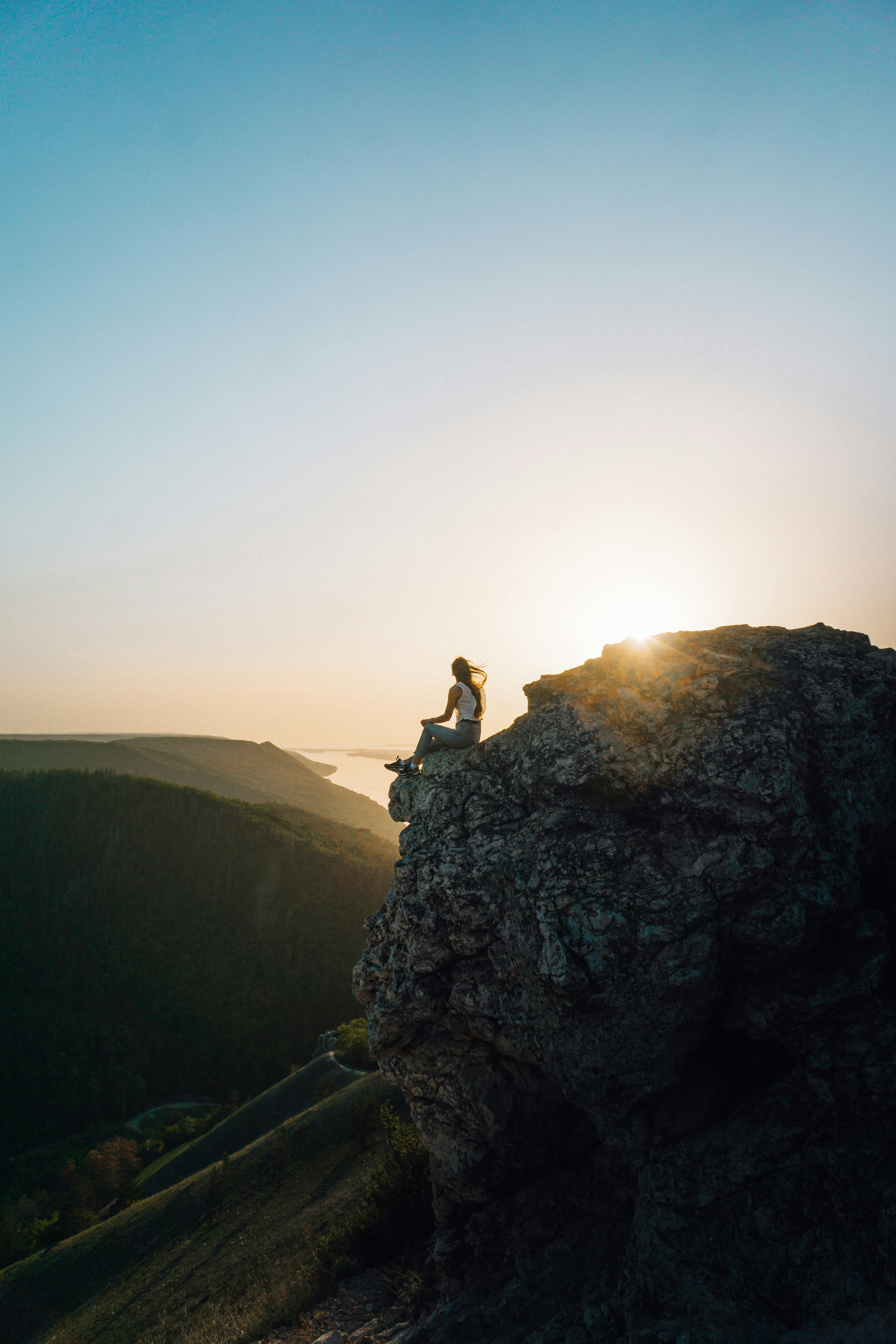 Person standing on rock formation during daytime photo – Free Cliff ...