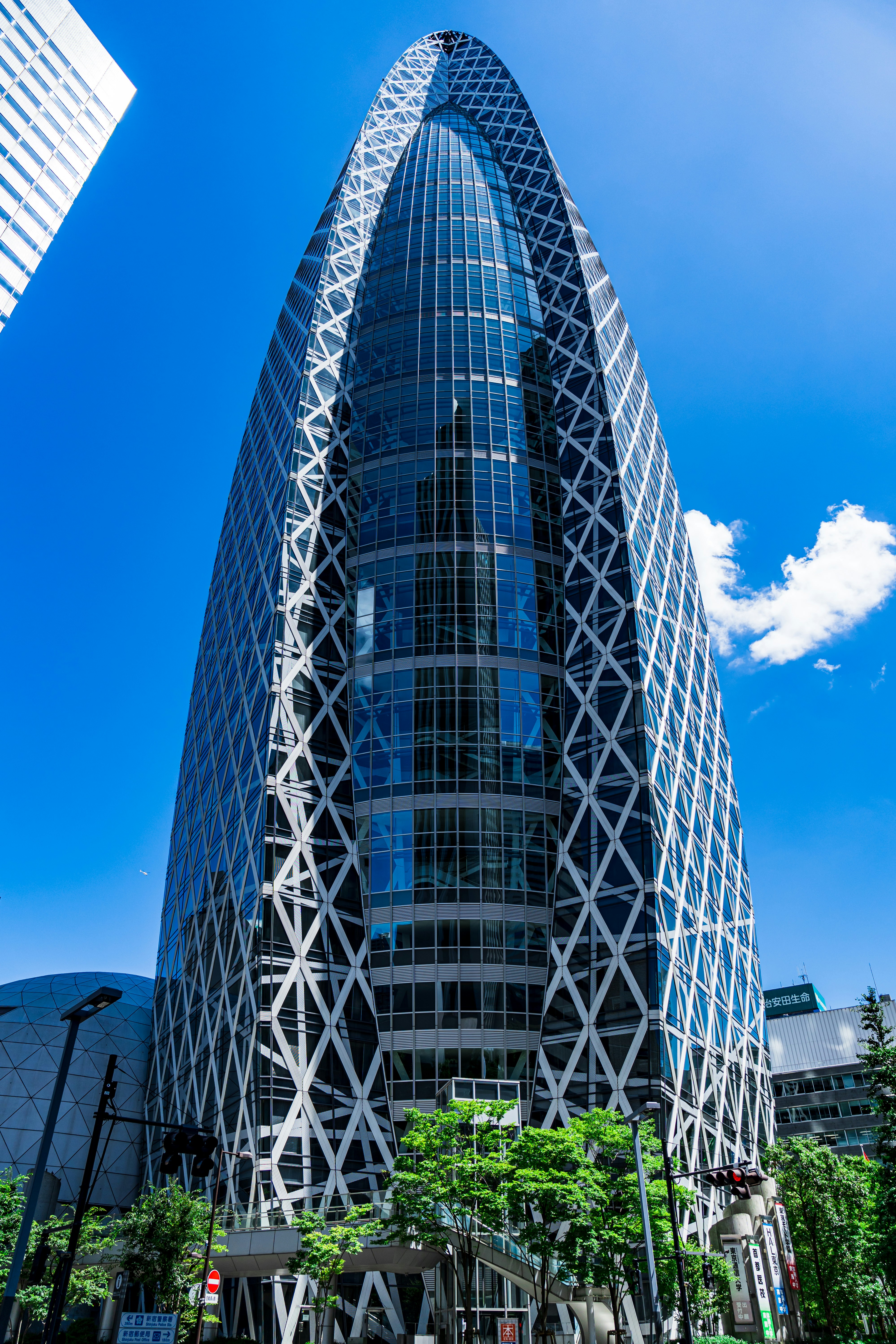 Arc of Lattice: The Curved Skyscraper Cutting Through Blue Sky