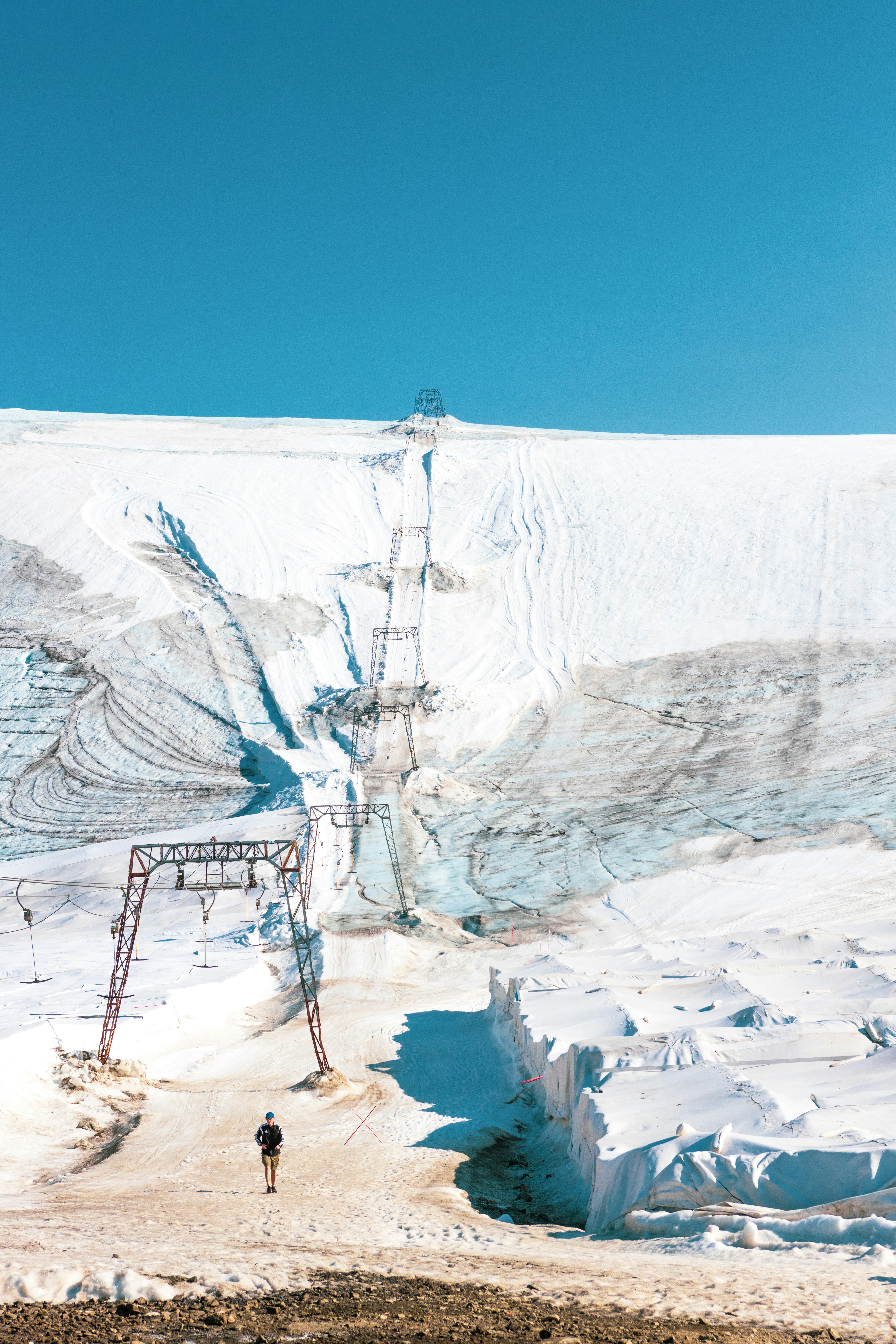 Lone Figure at the Ice Stairway Beneath a Cobalt Arctic Sky