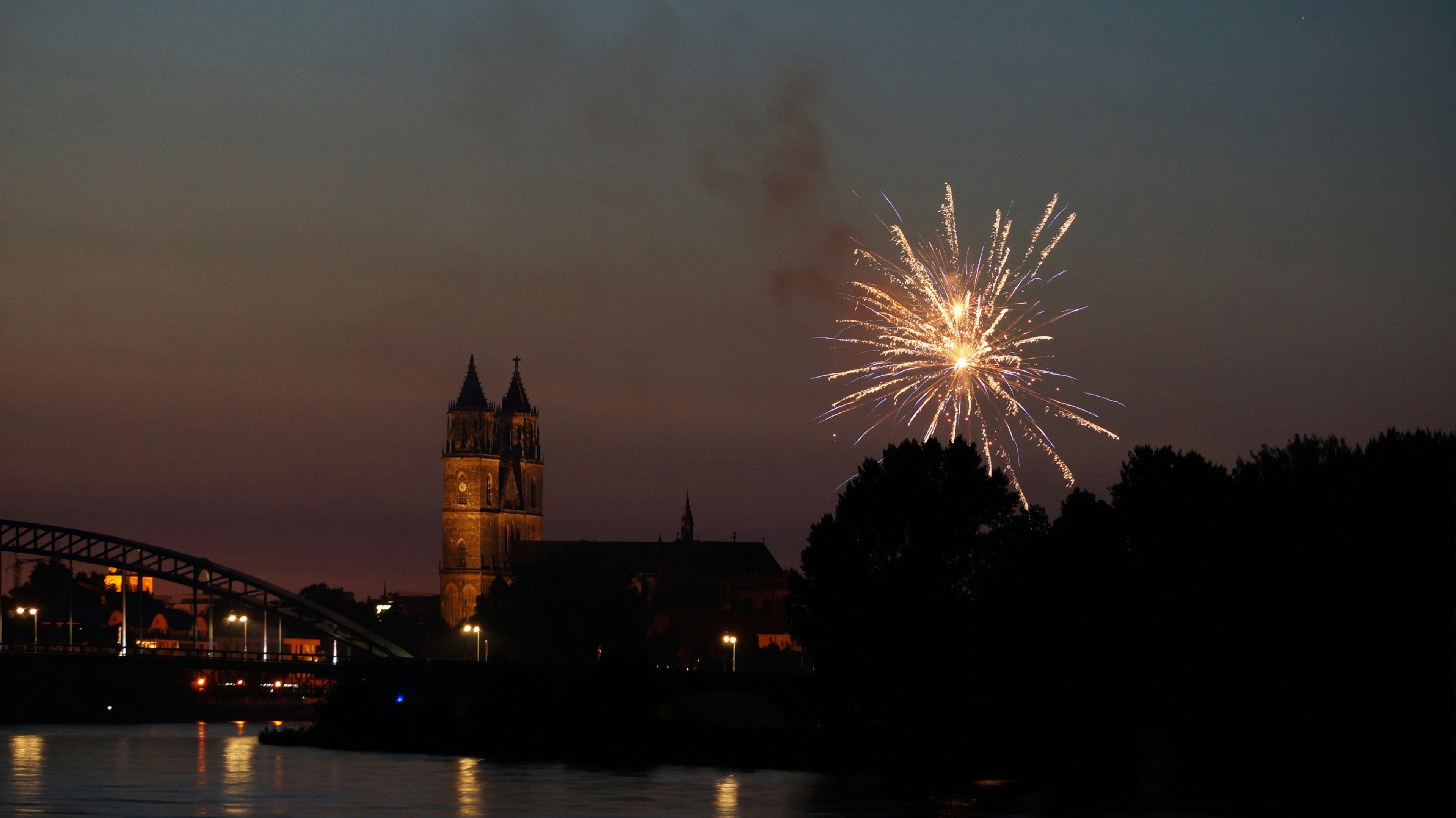 Fireworks display over brown concrete building during night time photo ...