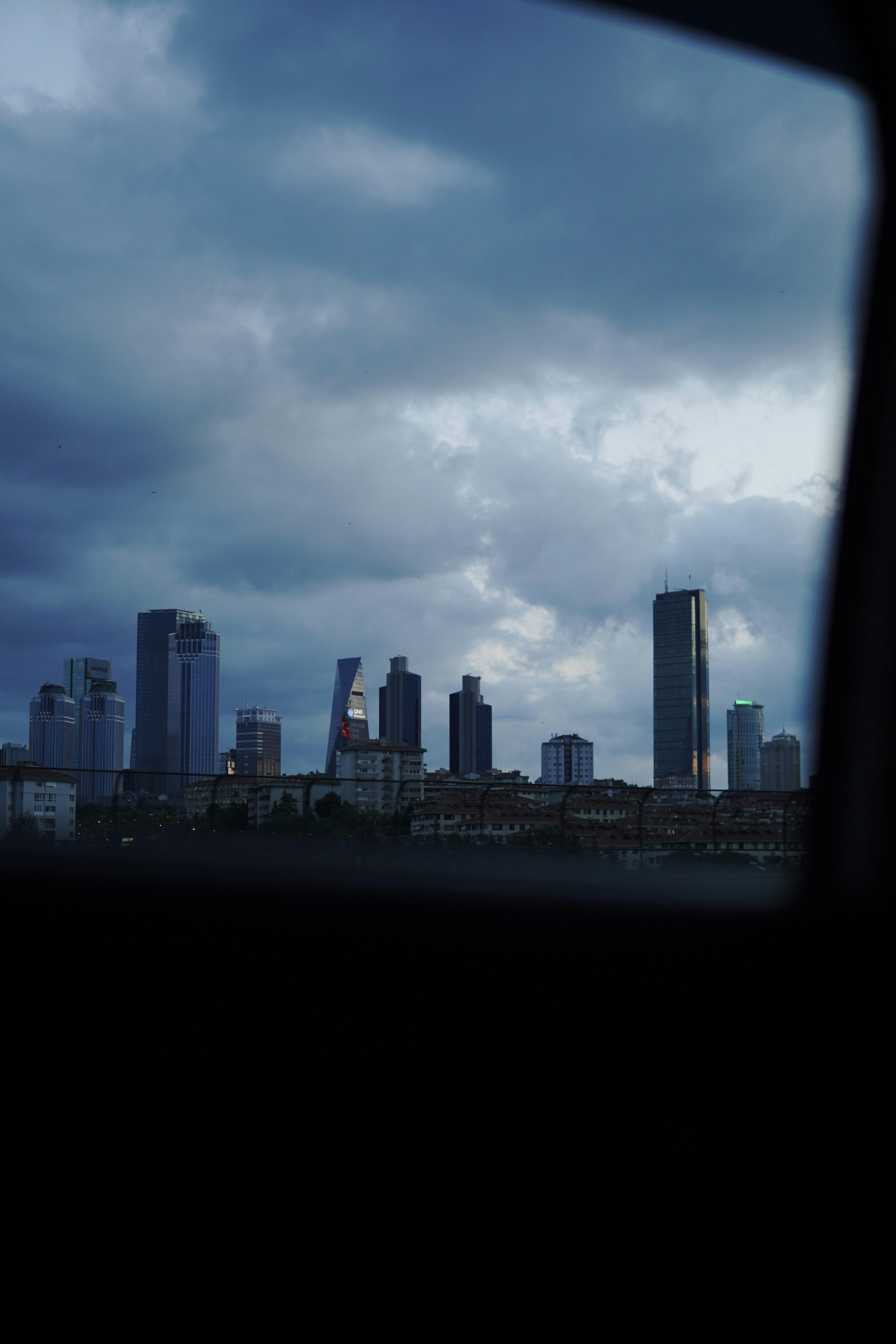 Blue Hour Skyline Framed by a Car Window's Shadow