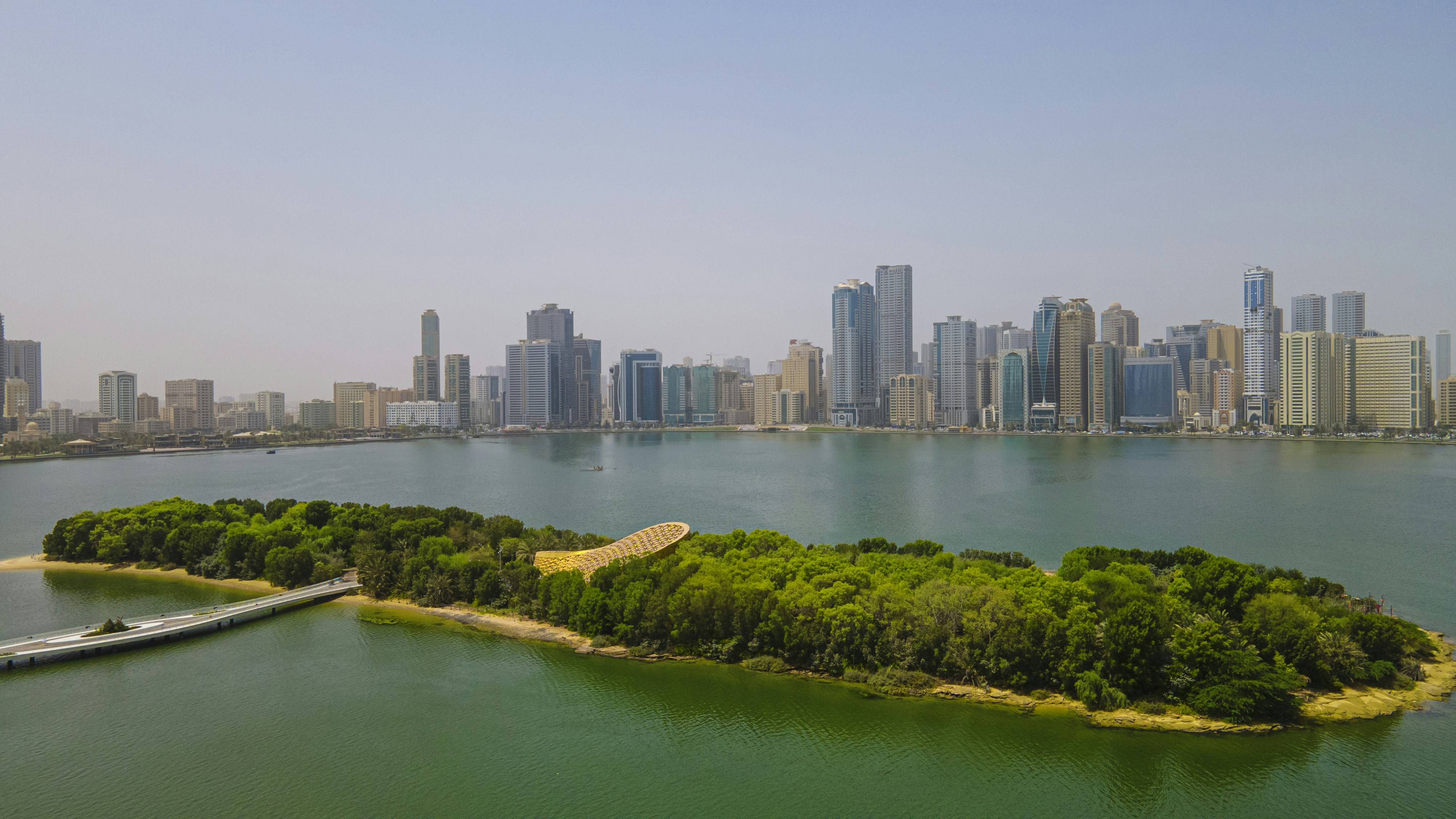 DJI Mavic Air 2 shot of the beautiful man made Noor Island of Sharjah, an Emirate of The United Arab Emirates.
The photo was taken from the height of 38 ft.  | body of water near city buildings during daytime