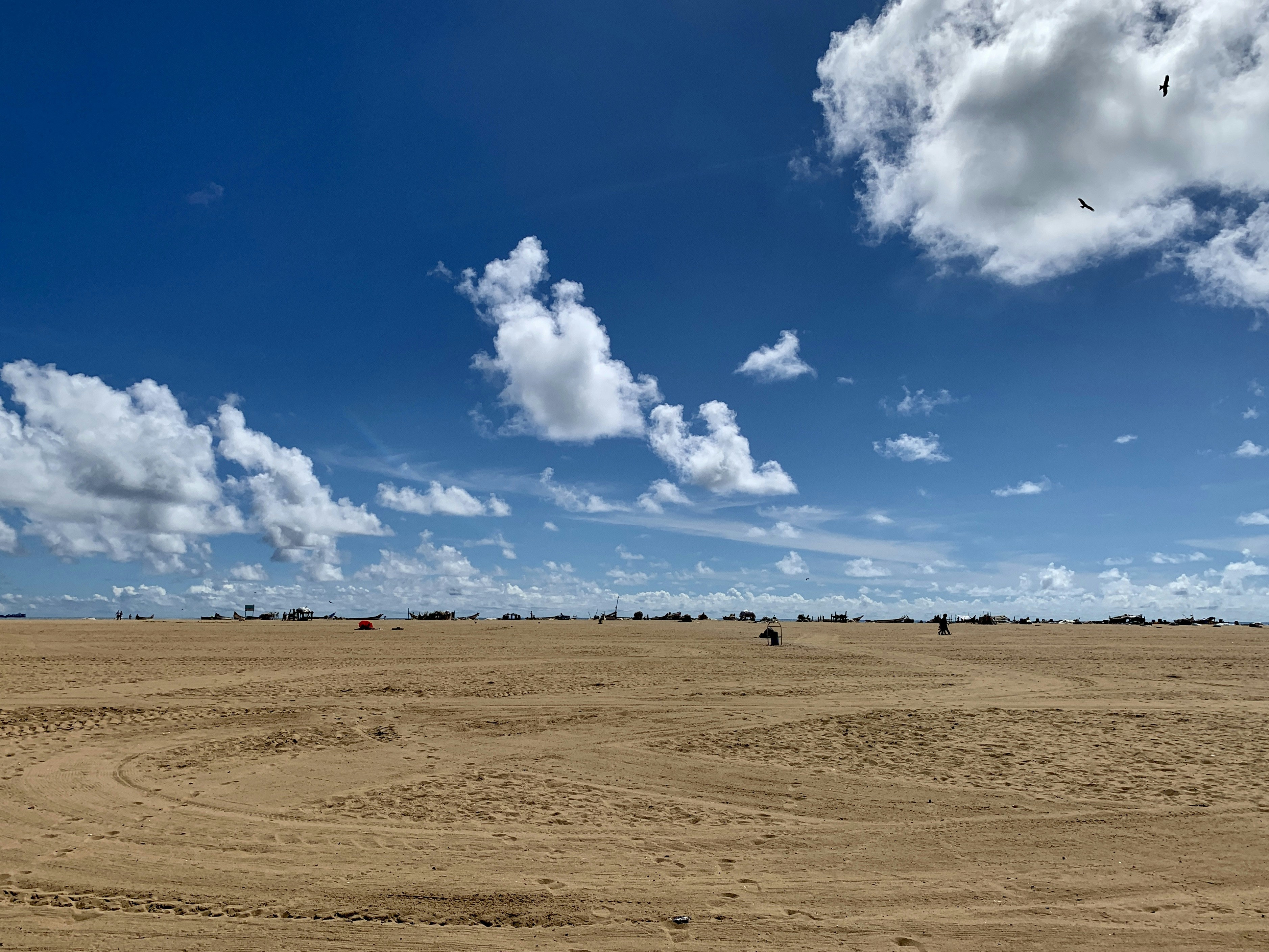 Horizon Ripples: Concentric Sand Patterns Beneath a Brushed-Blue Sky