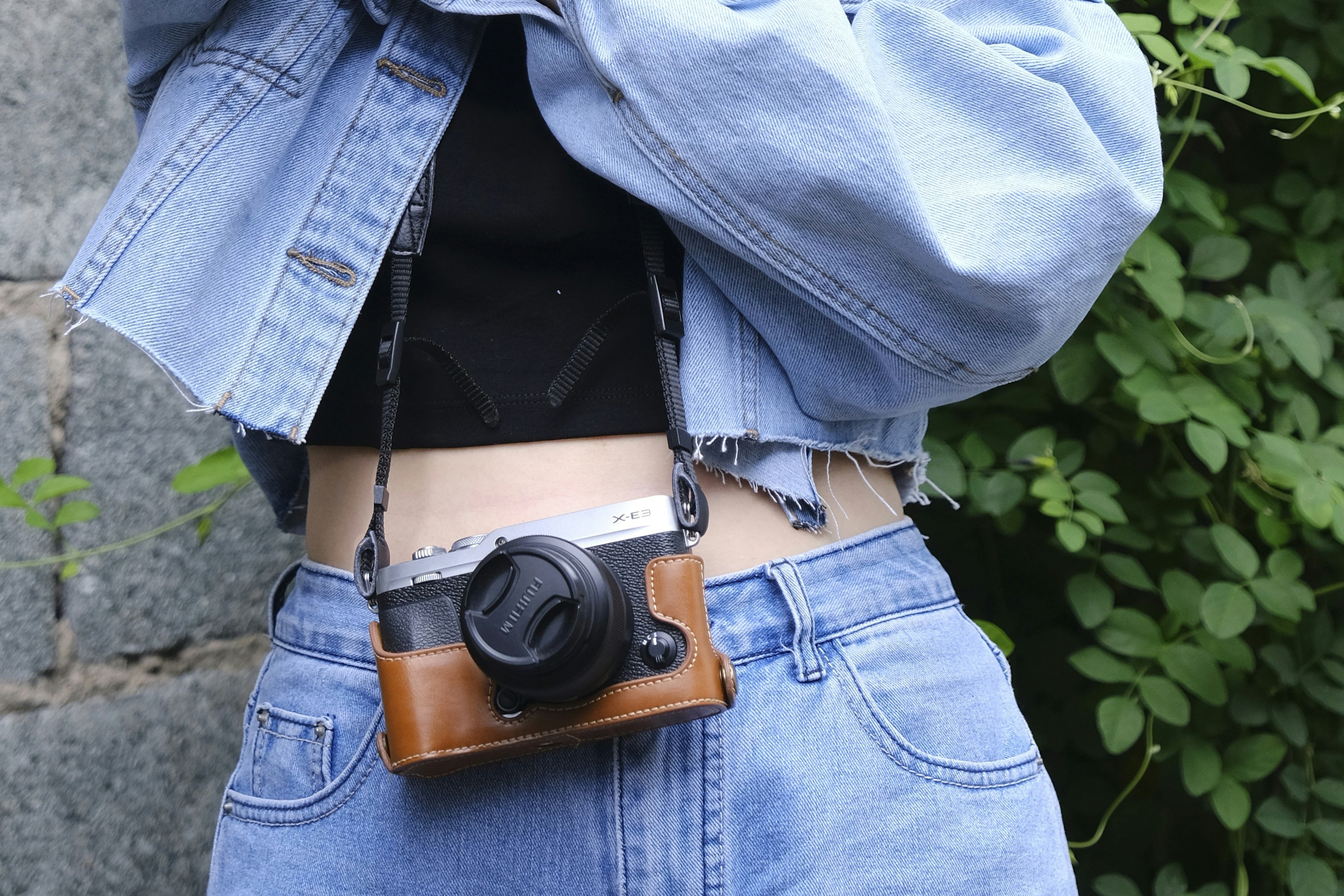 Leather-Case Focus: A Waist-Hung Camera Amid Denim Streetwear