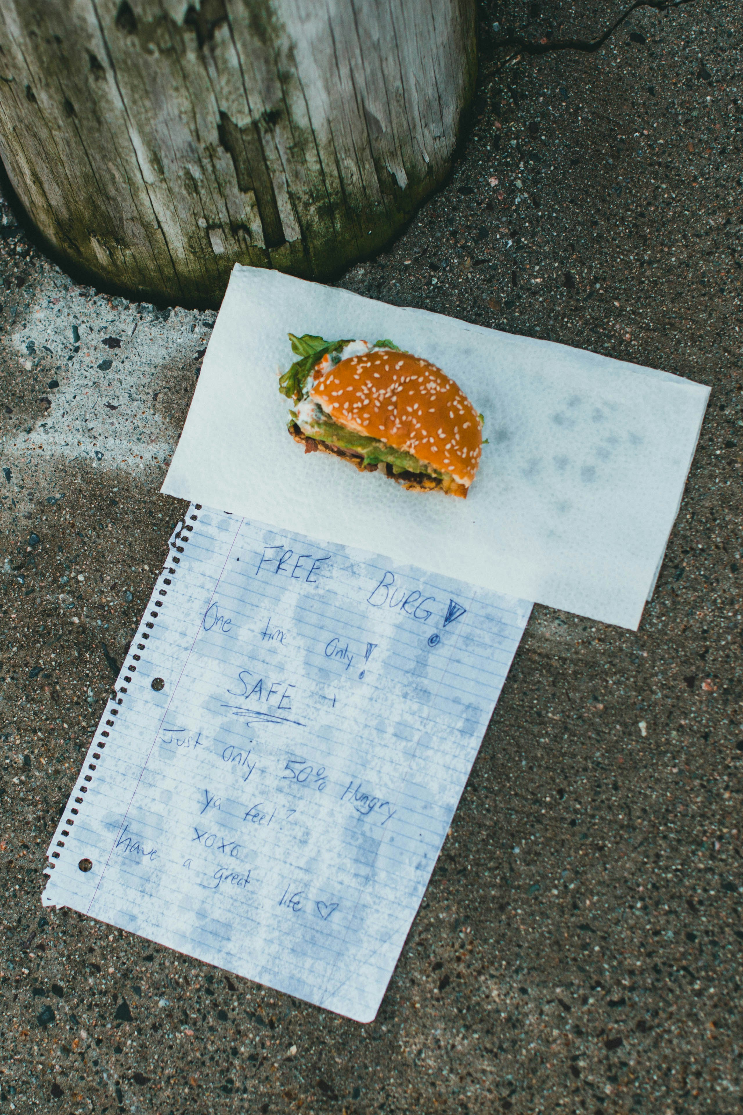 Sidewalk Snack: A Sesame Burger Paused by a Worn Notebook