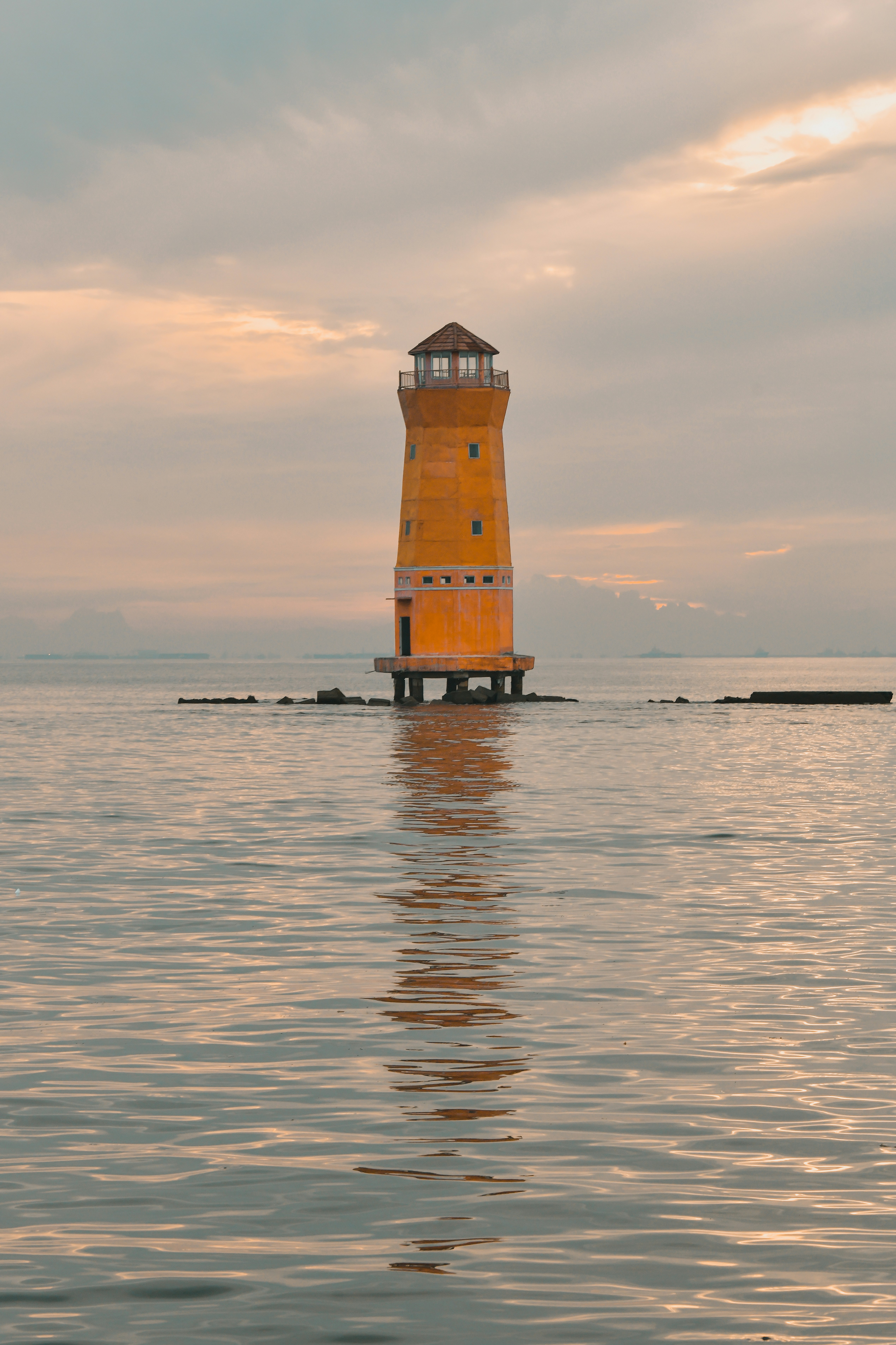 Beacon of Tranquility: The Yellow Lighthouse at Dusk