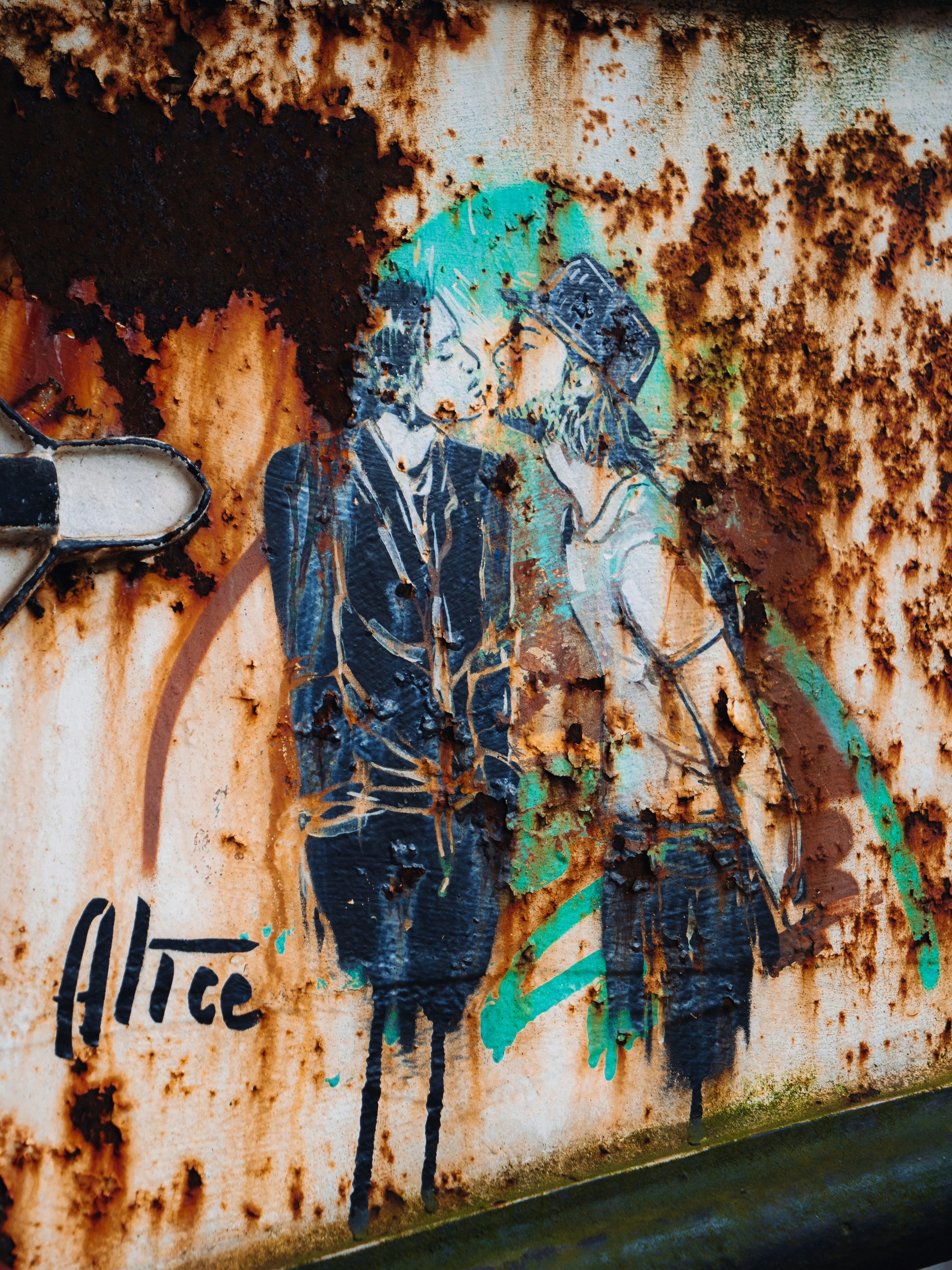 Teal Halo Embrace on a Rusted Wall