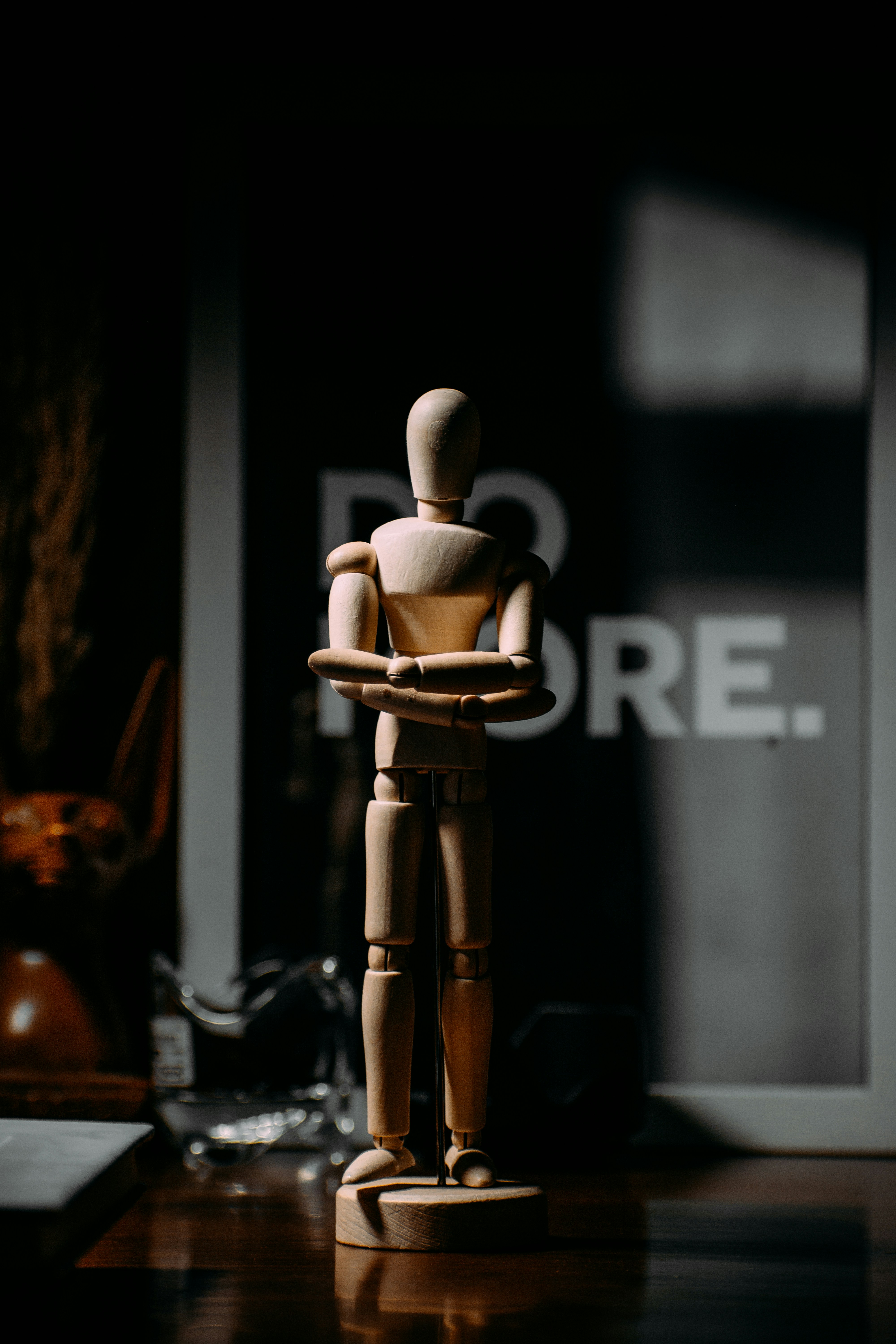 a wooden mannequin holding a tray of food
