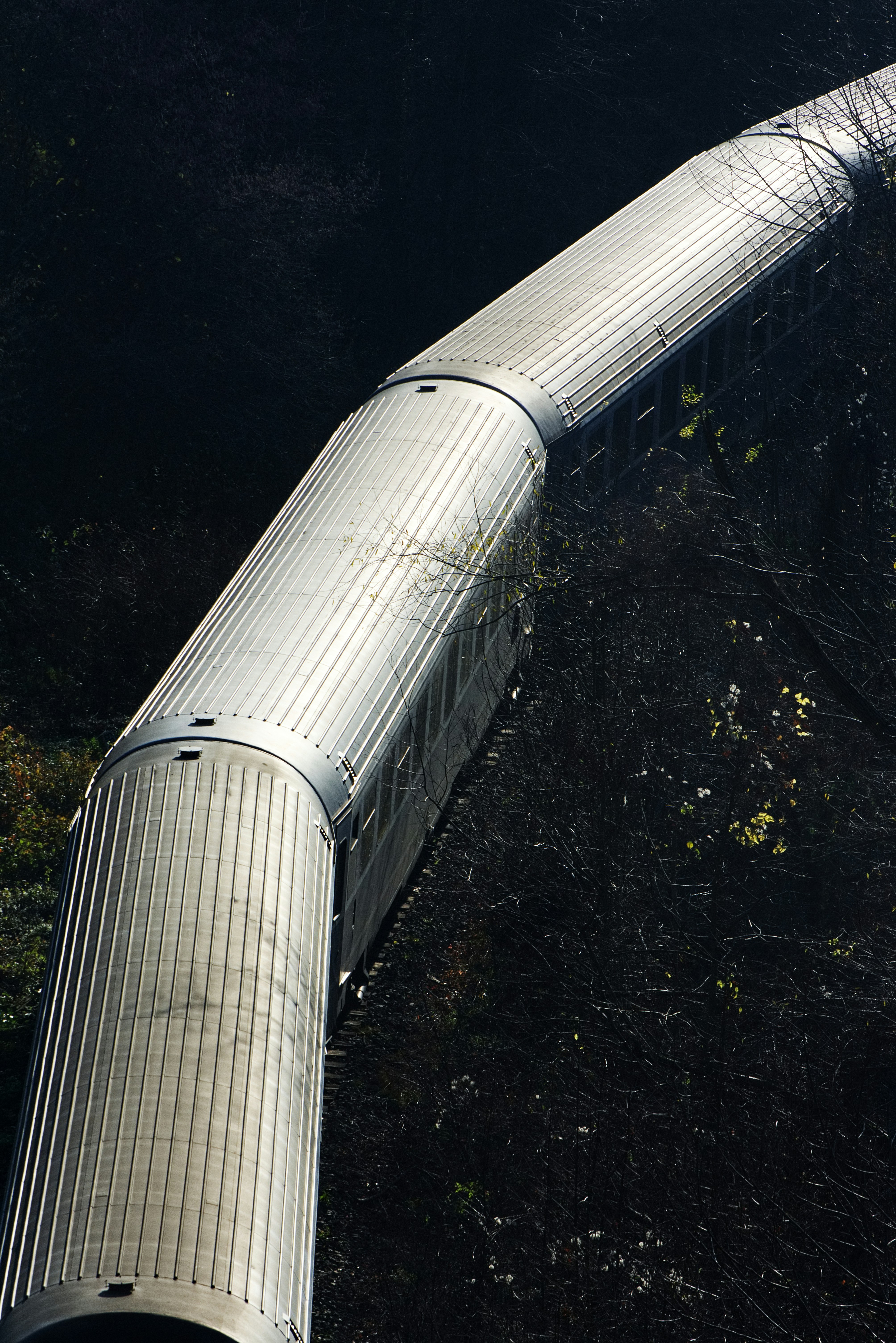 Snaking Silver Conduit: An Aerial Study of a Curved Industrial Pipeline