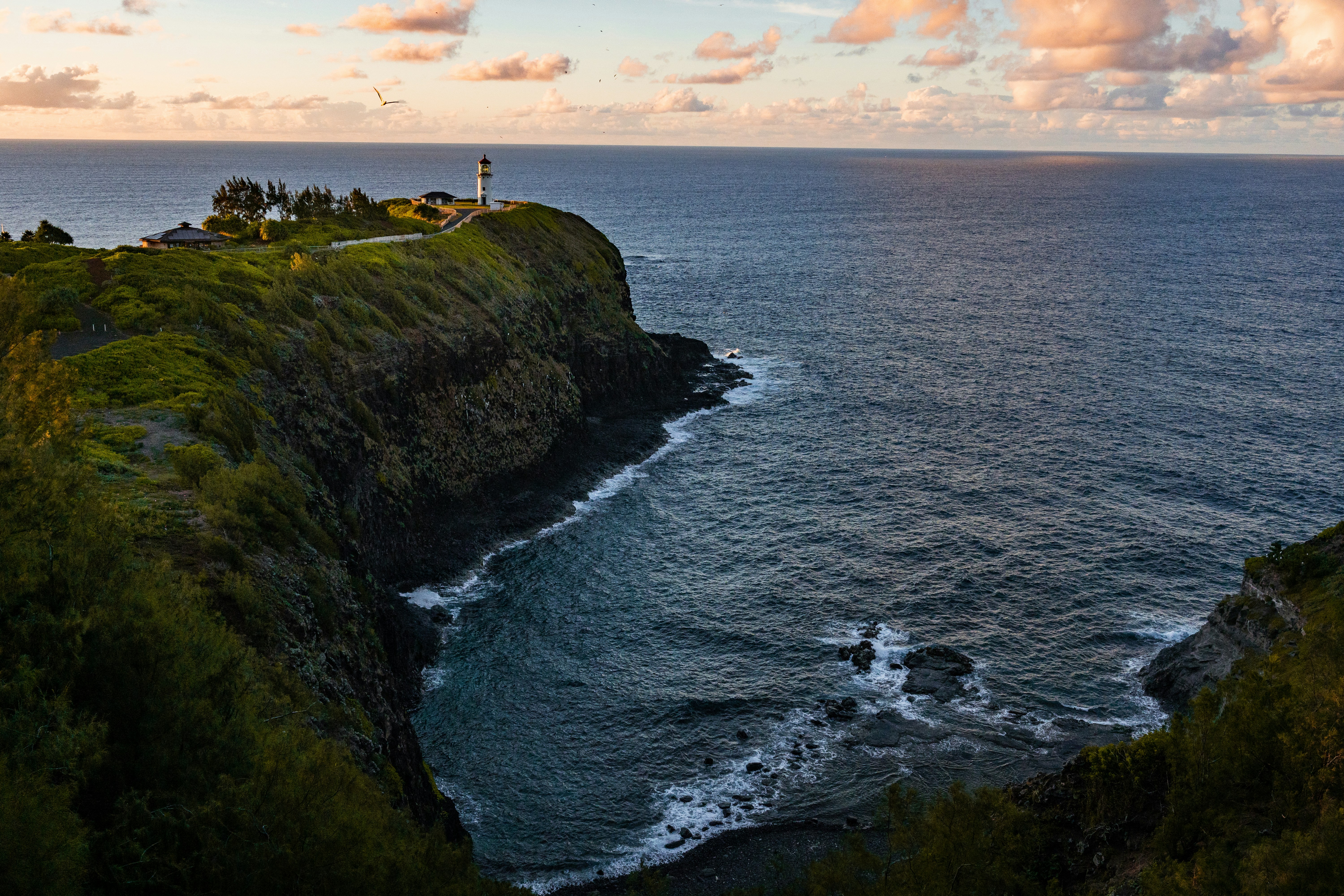 Edge of Light: Sunset Lighthouse Over the Cliff