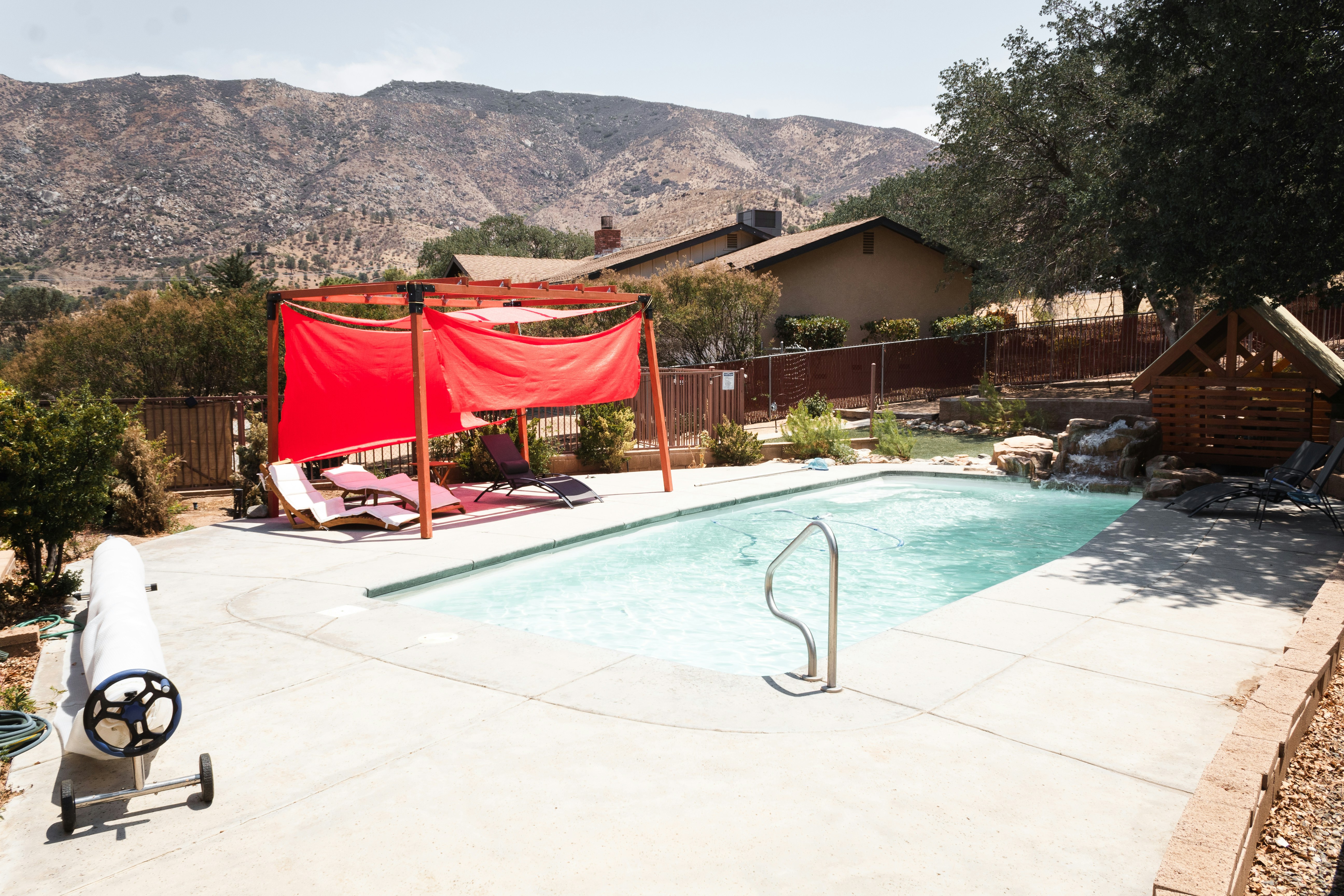 Red and white textiles hanged on string near swimming pool during ...