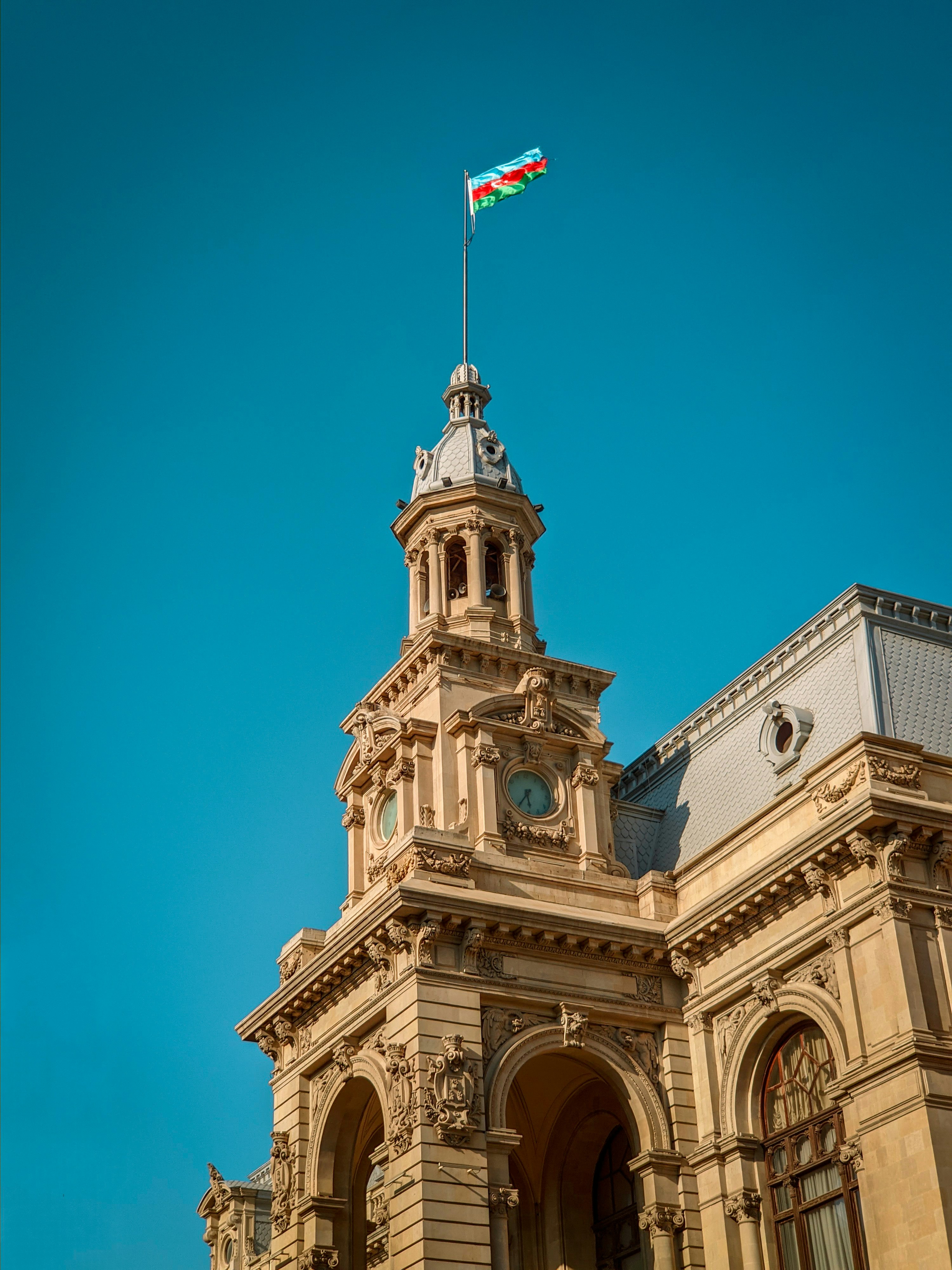 Baku City Executive Power | brown concrete building with flag of us a on top