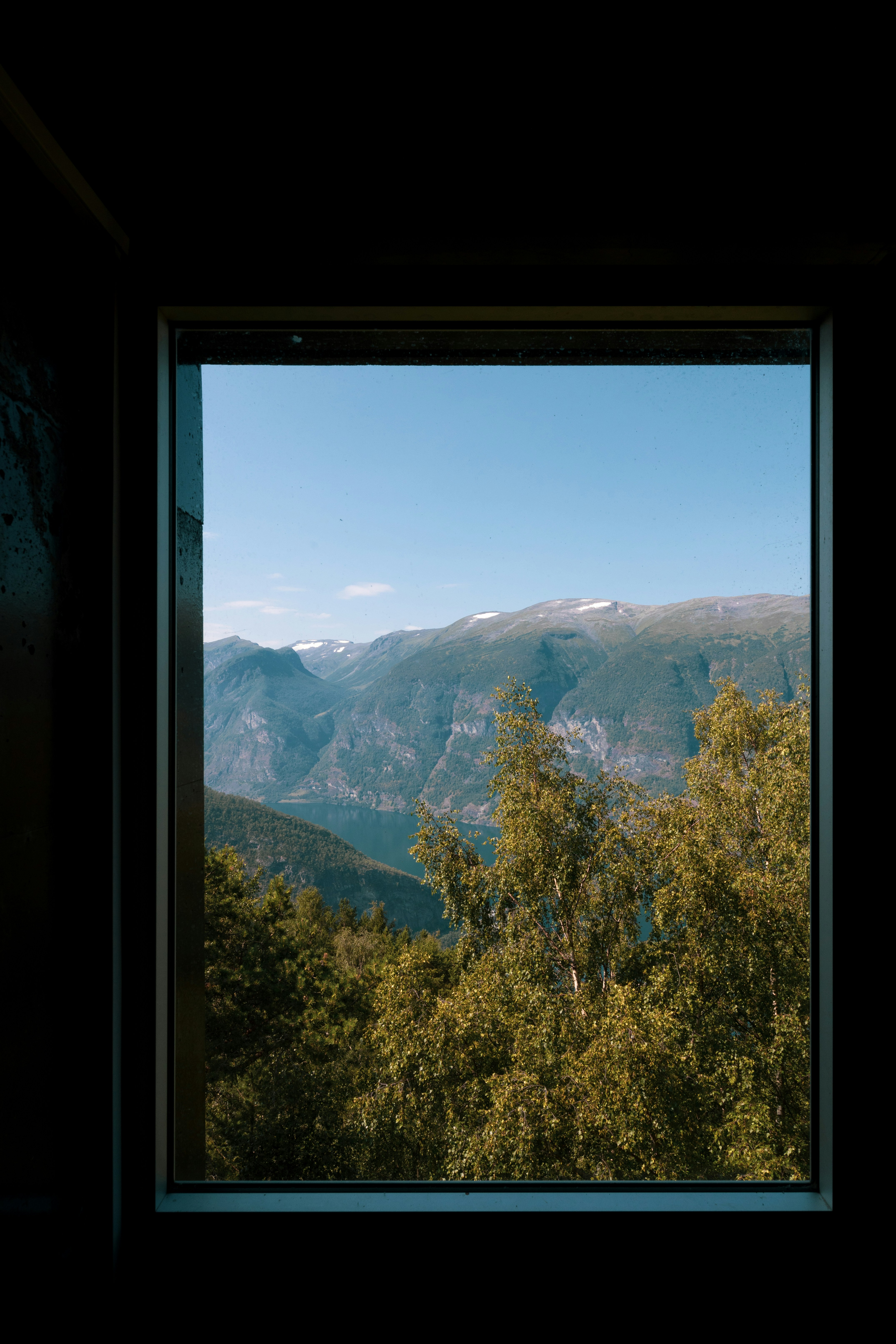 Framed Peaks: Alpine Panorama Beyond a Dim Window