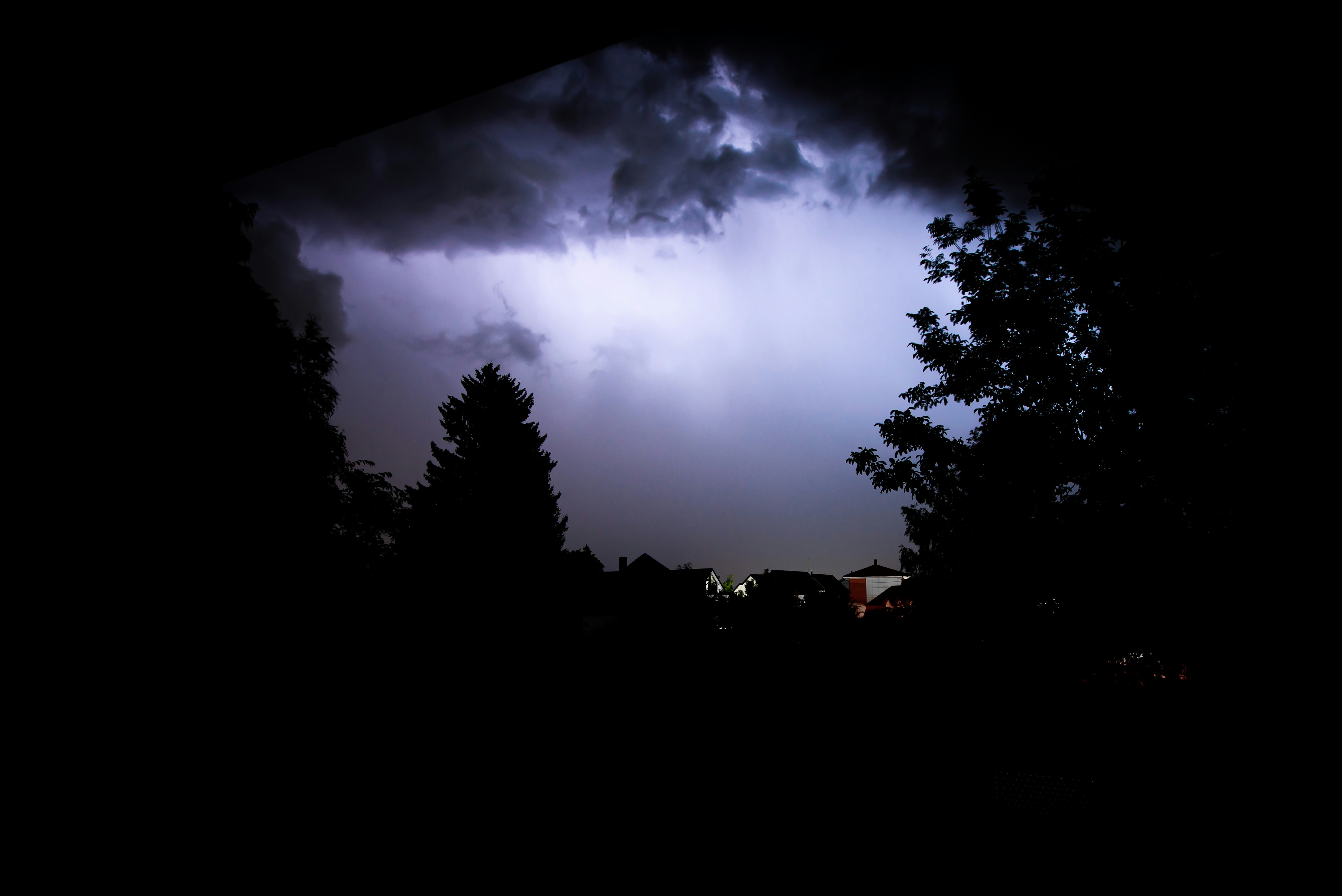 Midnight Storm Over a Suburban Silhouette