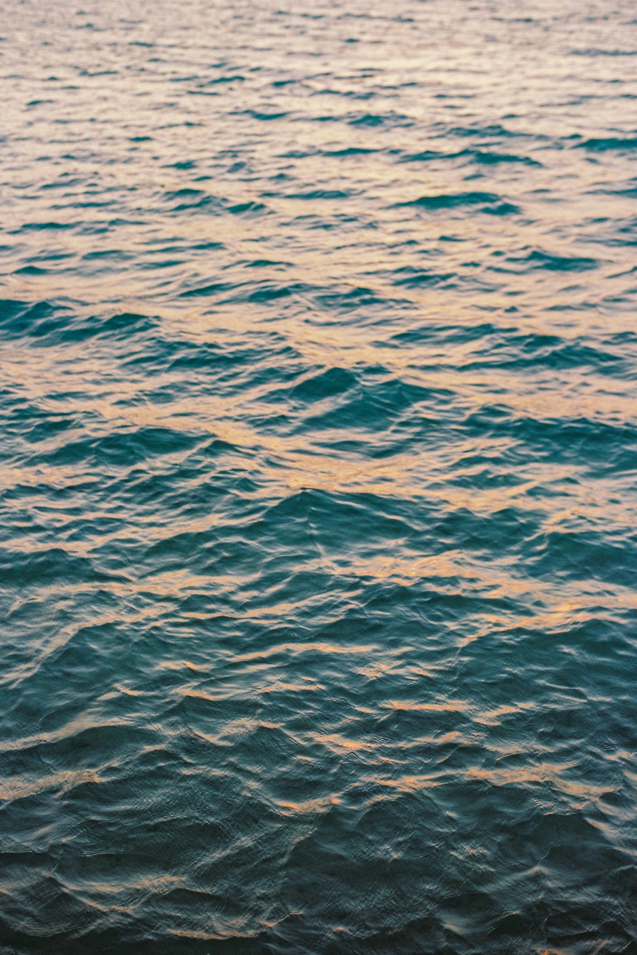 Dusk-Teal Ripples Across a Sun-Kissed Sea