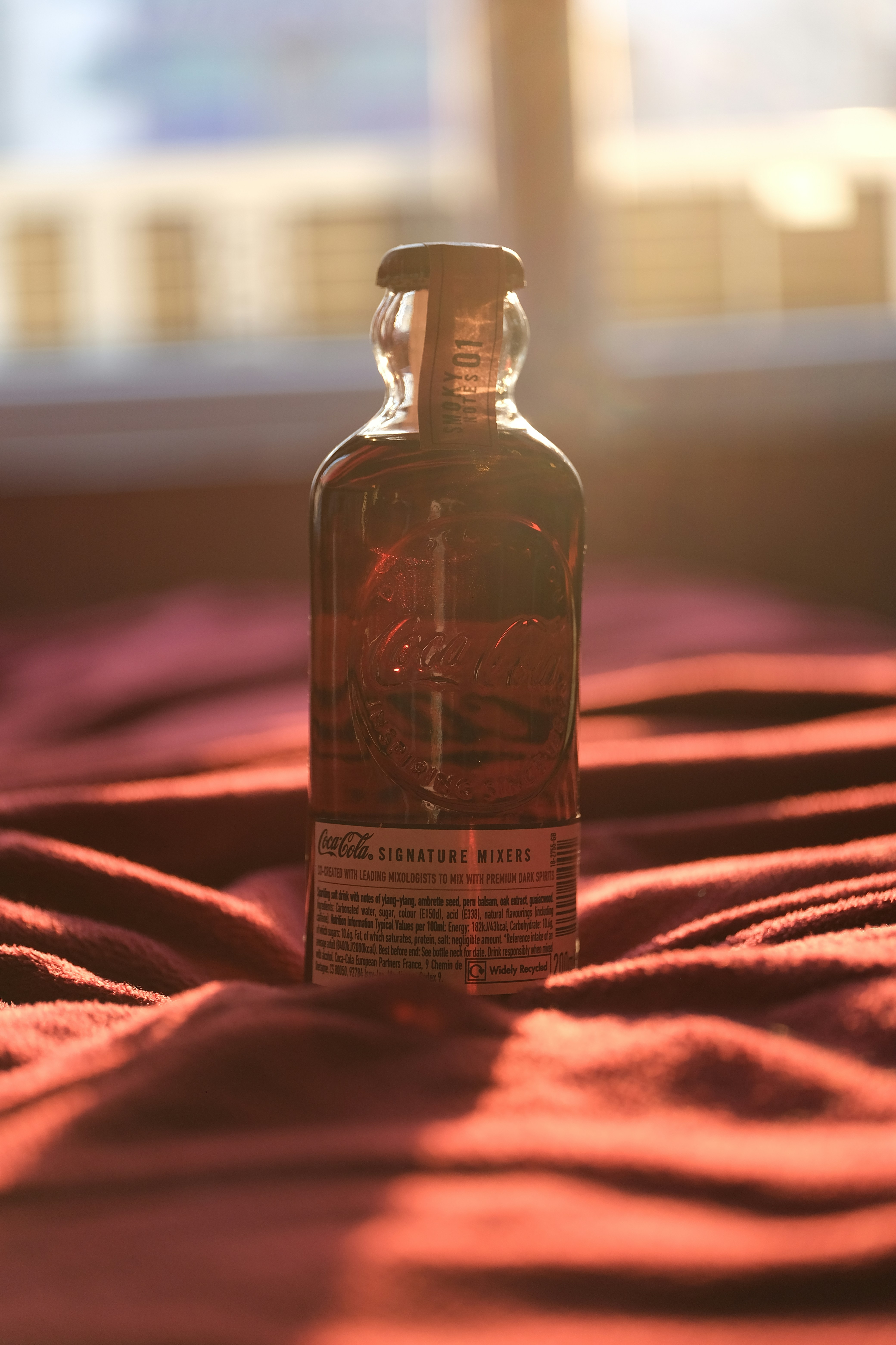 red labeled bottle on red textile