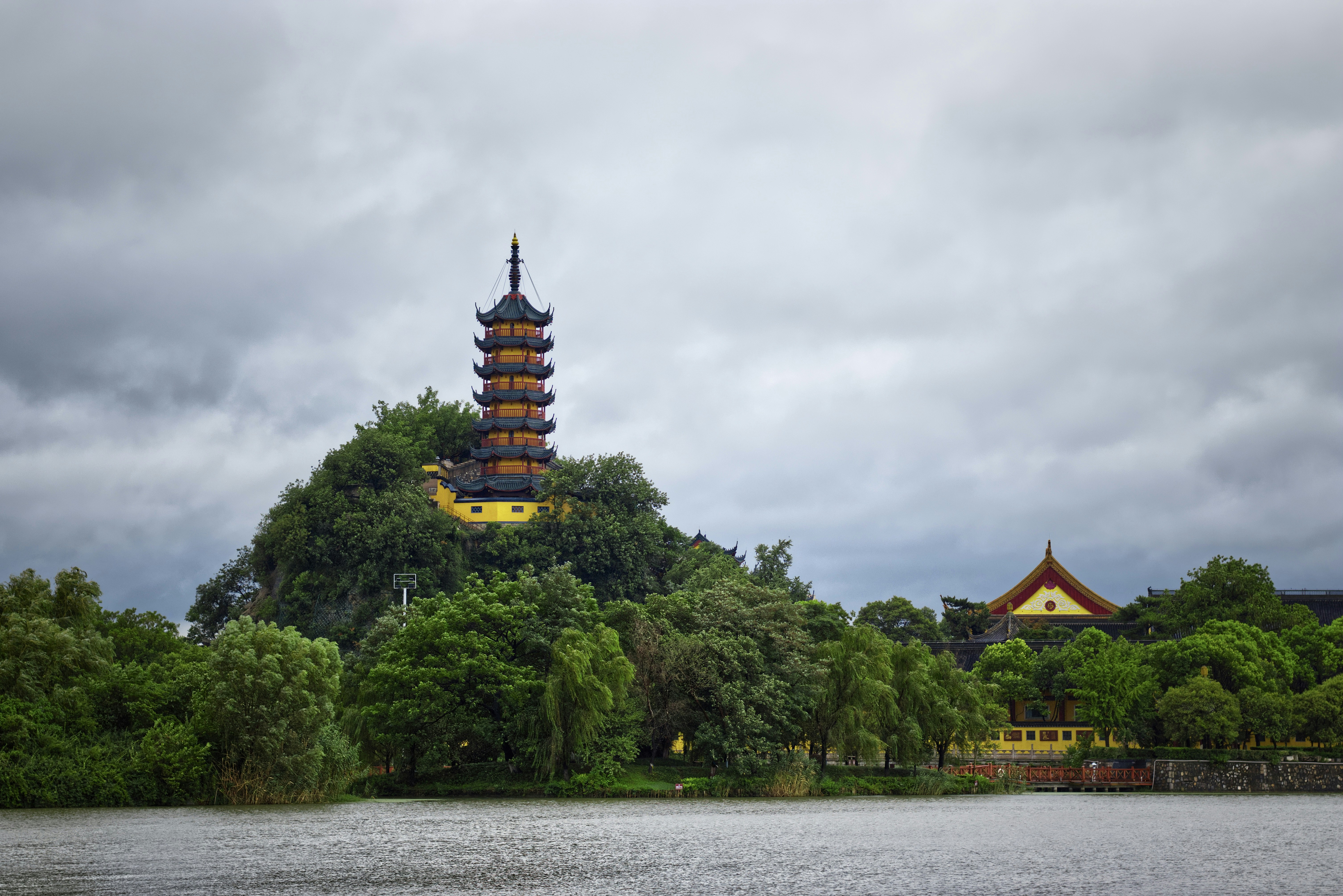 Golden Pagoda on Lake Isle: Tranquil Harmony of Water, Trees, and Temple