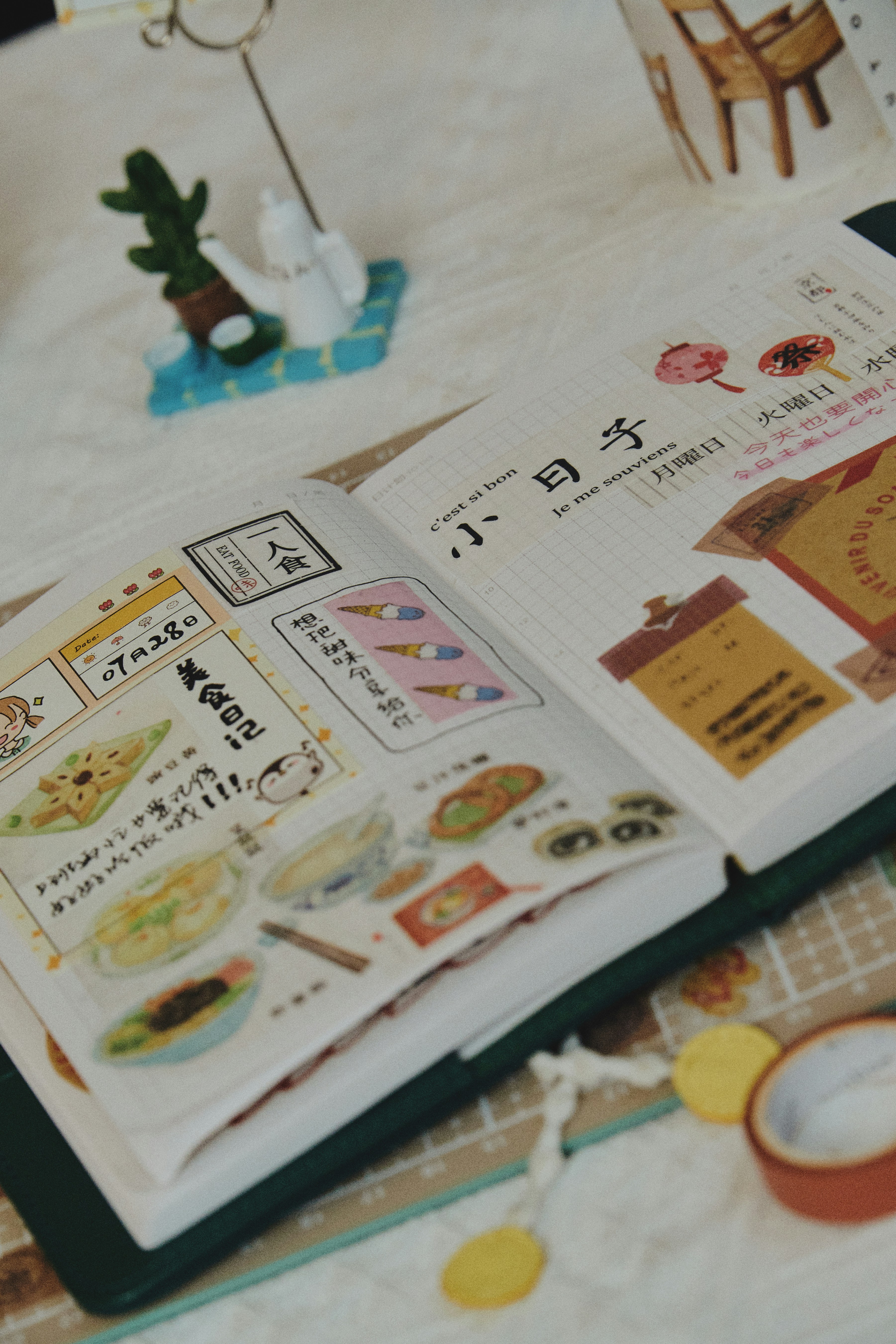 Open cookbook spread with illustrated food stickers on a cozy desk